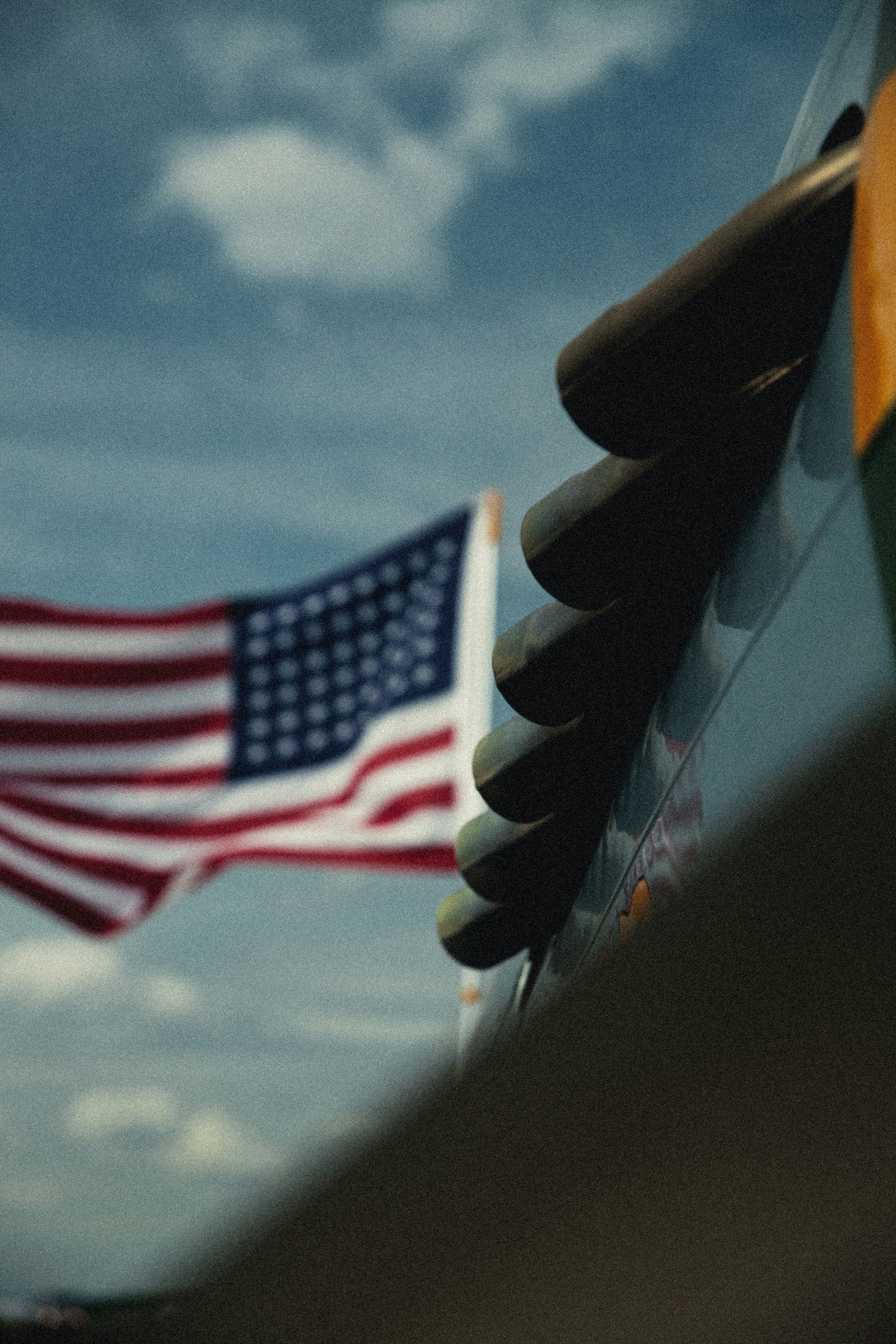 Flag in Motion beside a Riser: A Close-Quarter Perspective