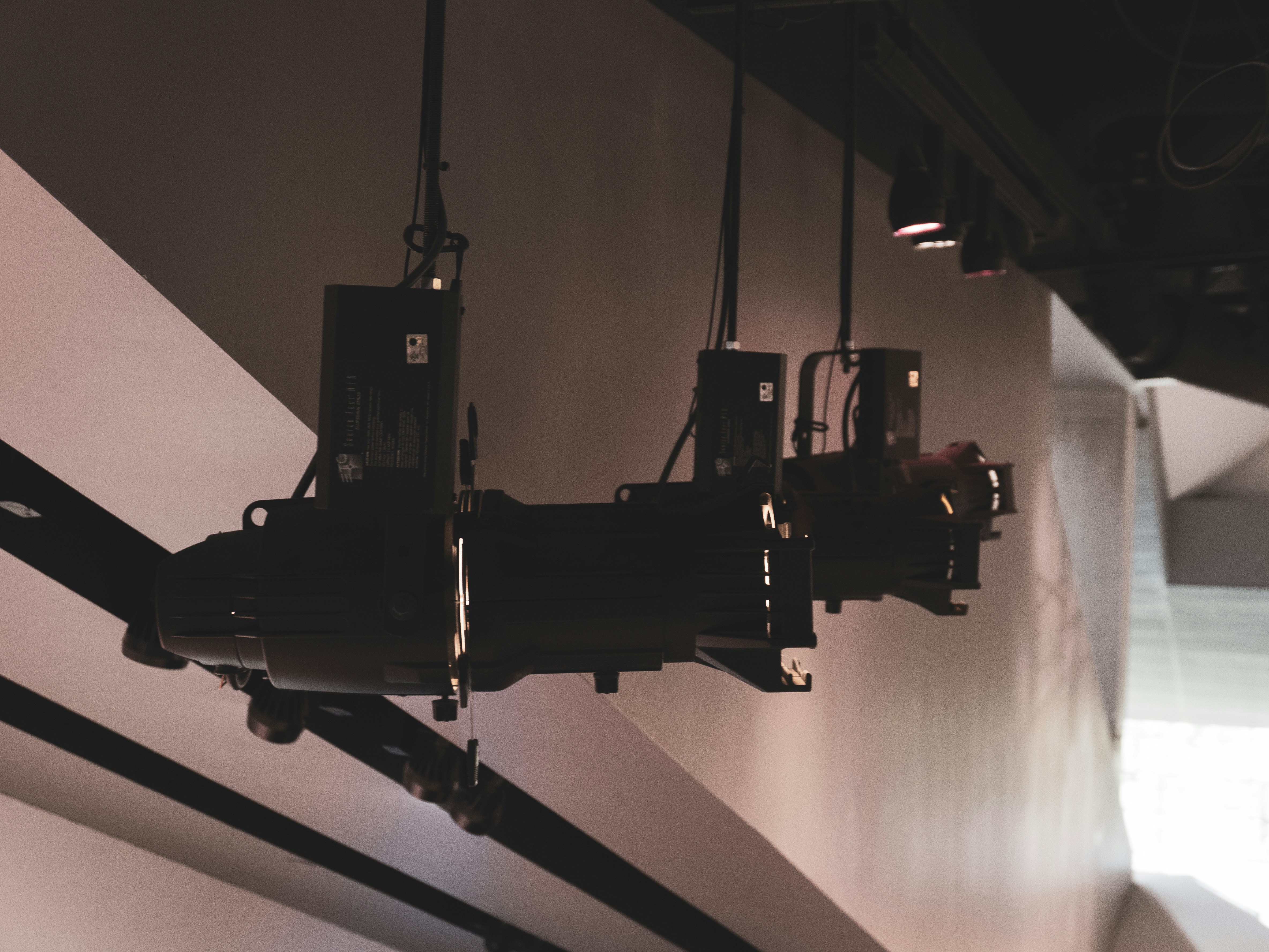 Overhead Stage Lights Hang in Silence Over a Dim Backstage