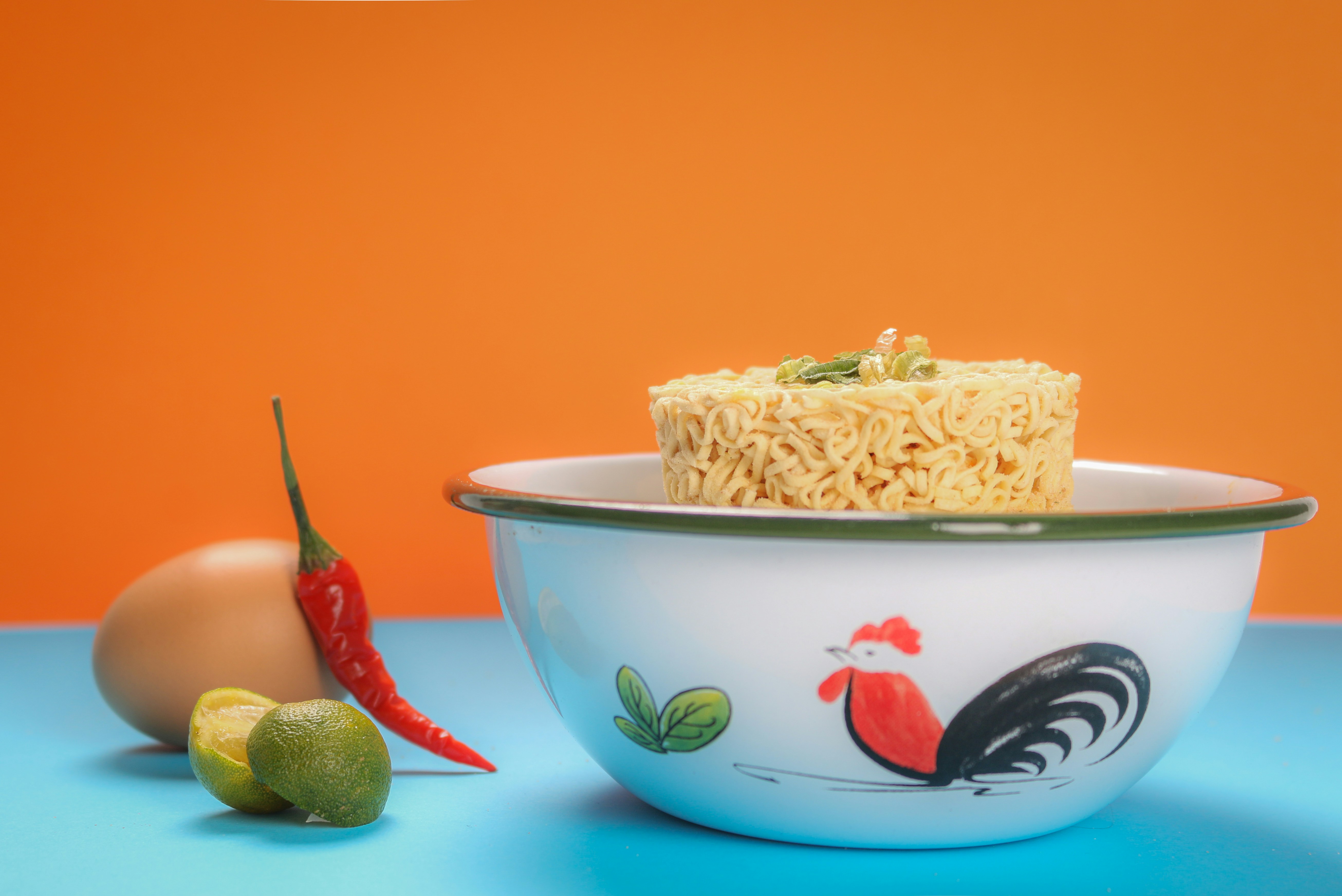 Noodle Nest in a Rooster Bowl: A Bright Still-Life in Orange and Teal