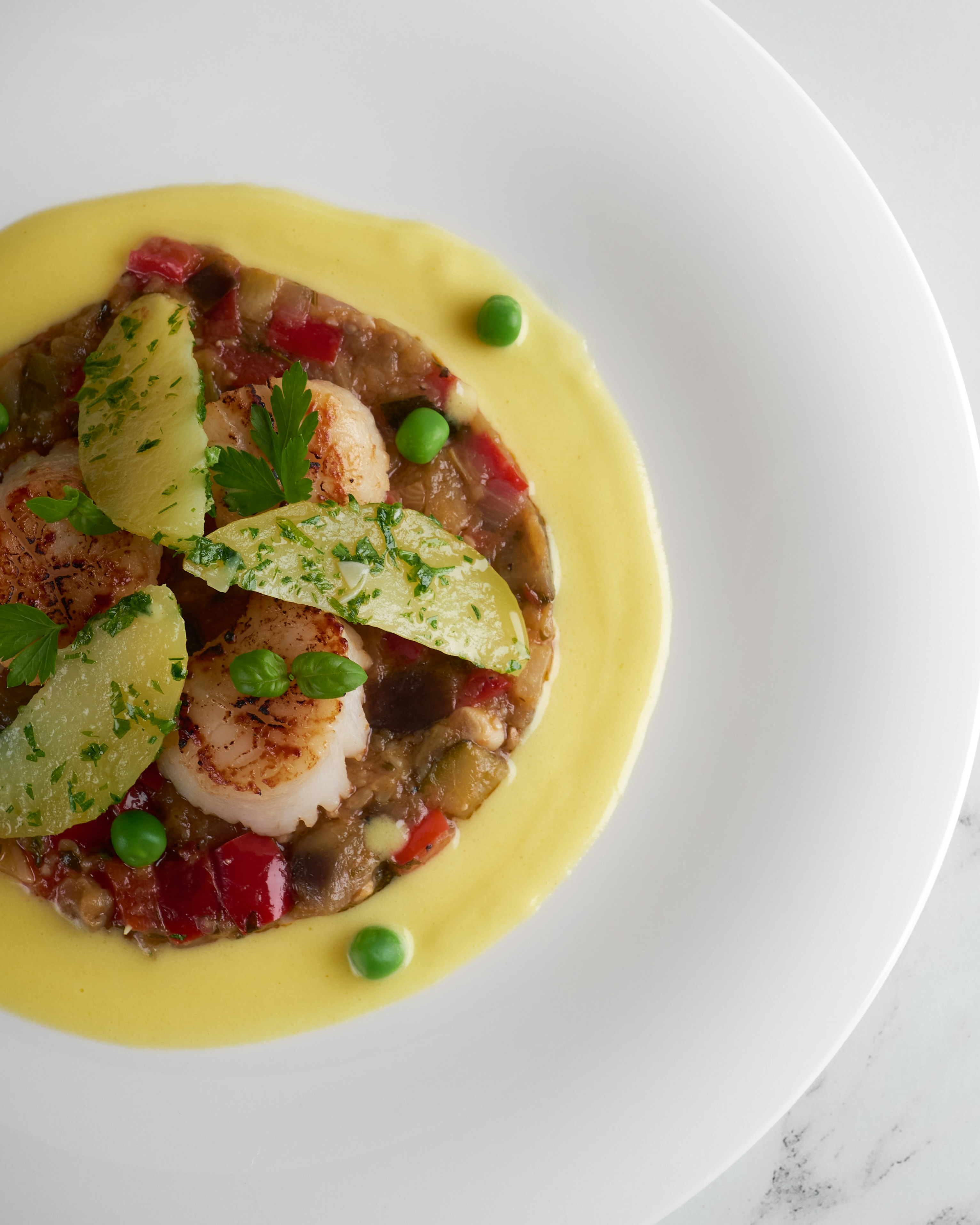 Seared Scallop Mosaic in Golden Velvet Sauce with Garden Vegetables