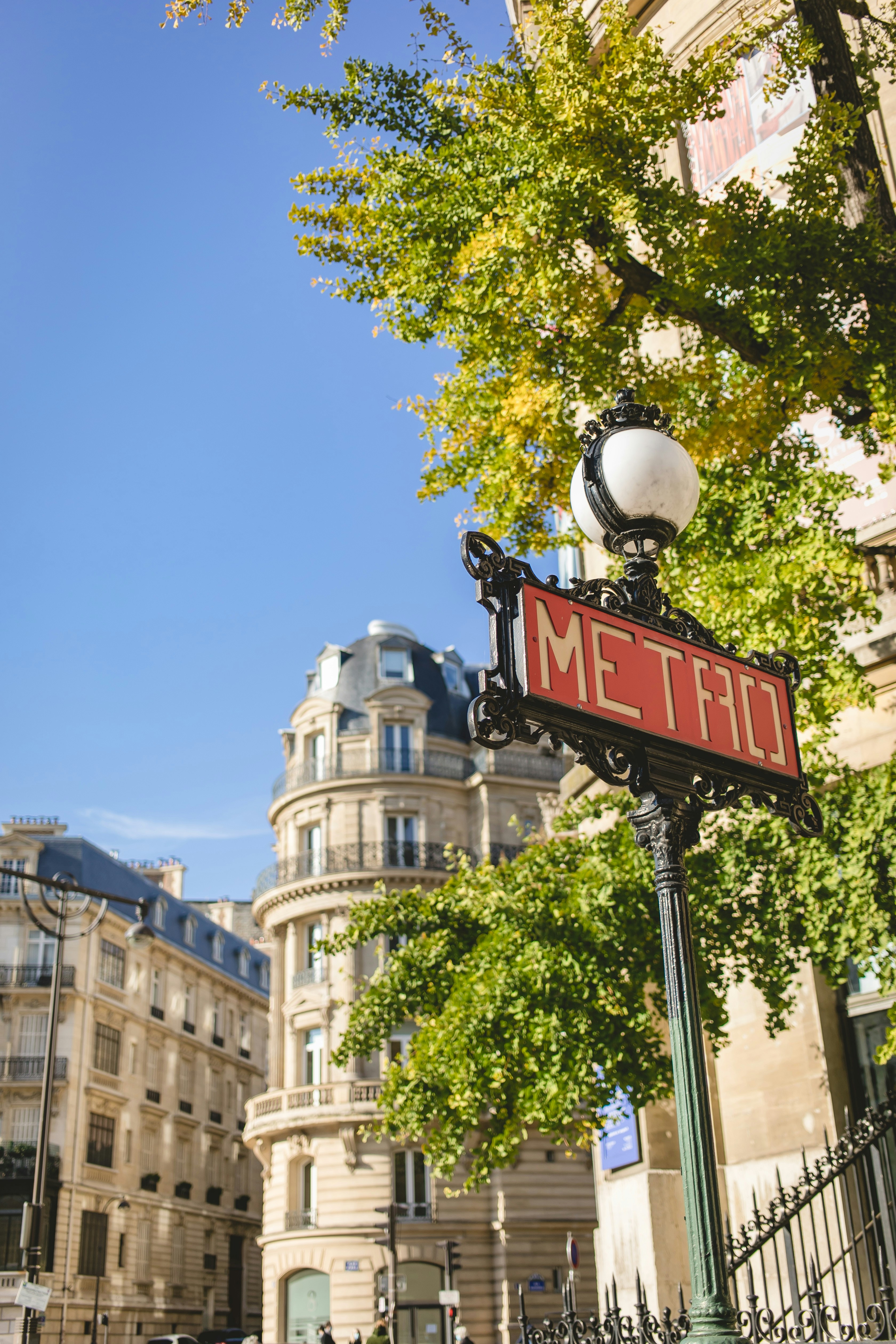 METRO Sign Framed by Sunlit Parisian Façades