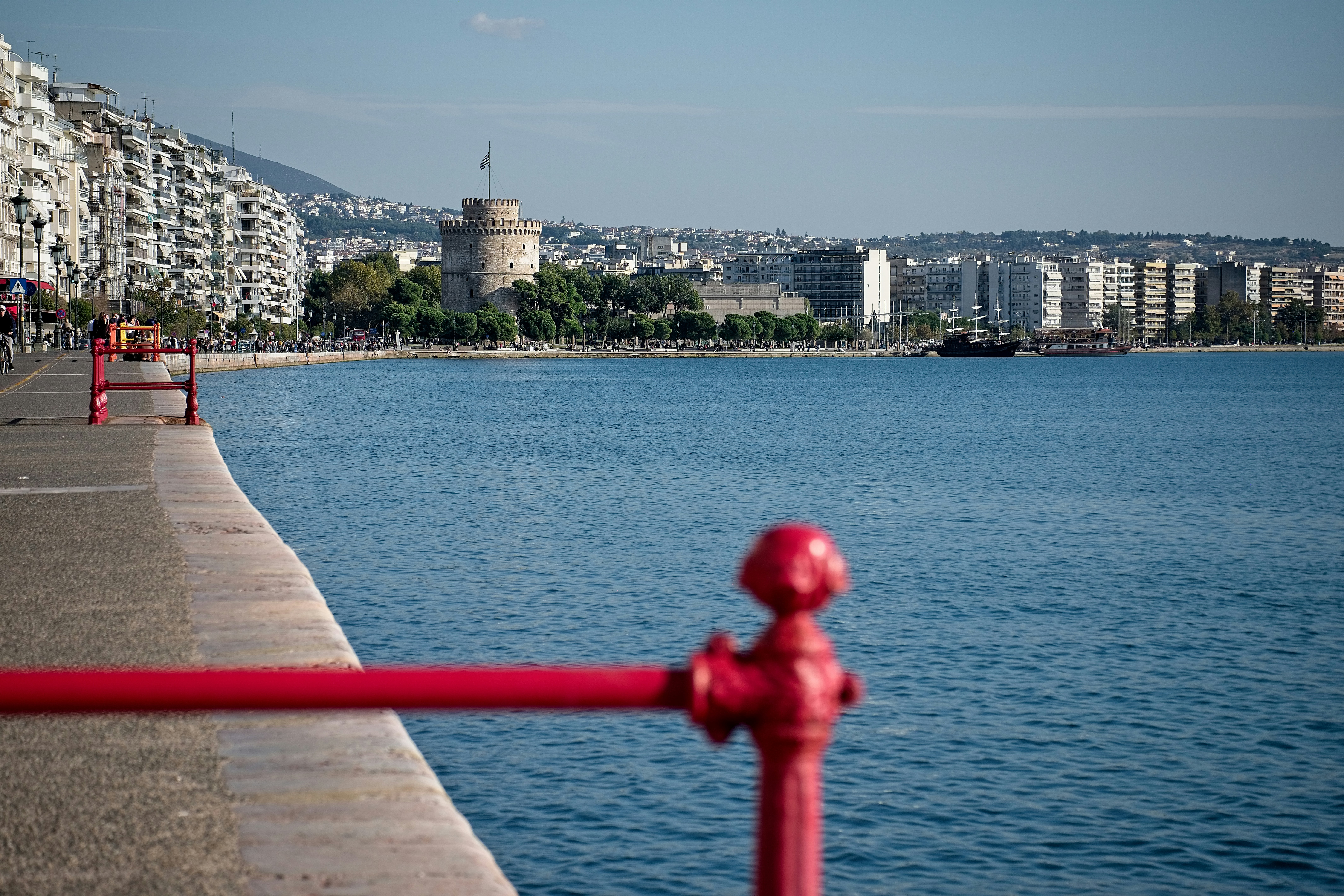 Red Handrail Framing the Waterfront: A Quiet Coastal Avenue