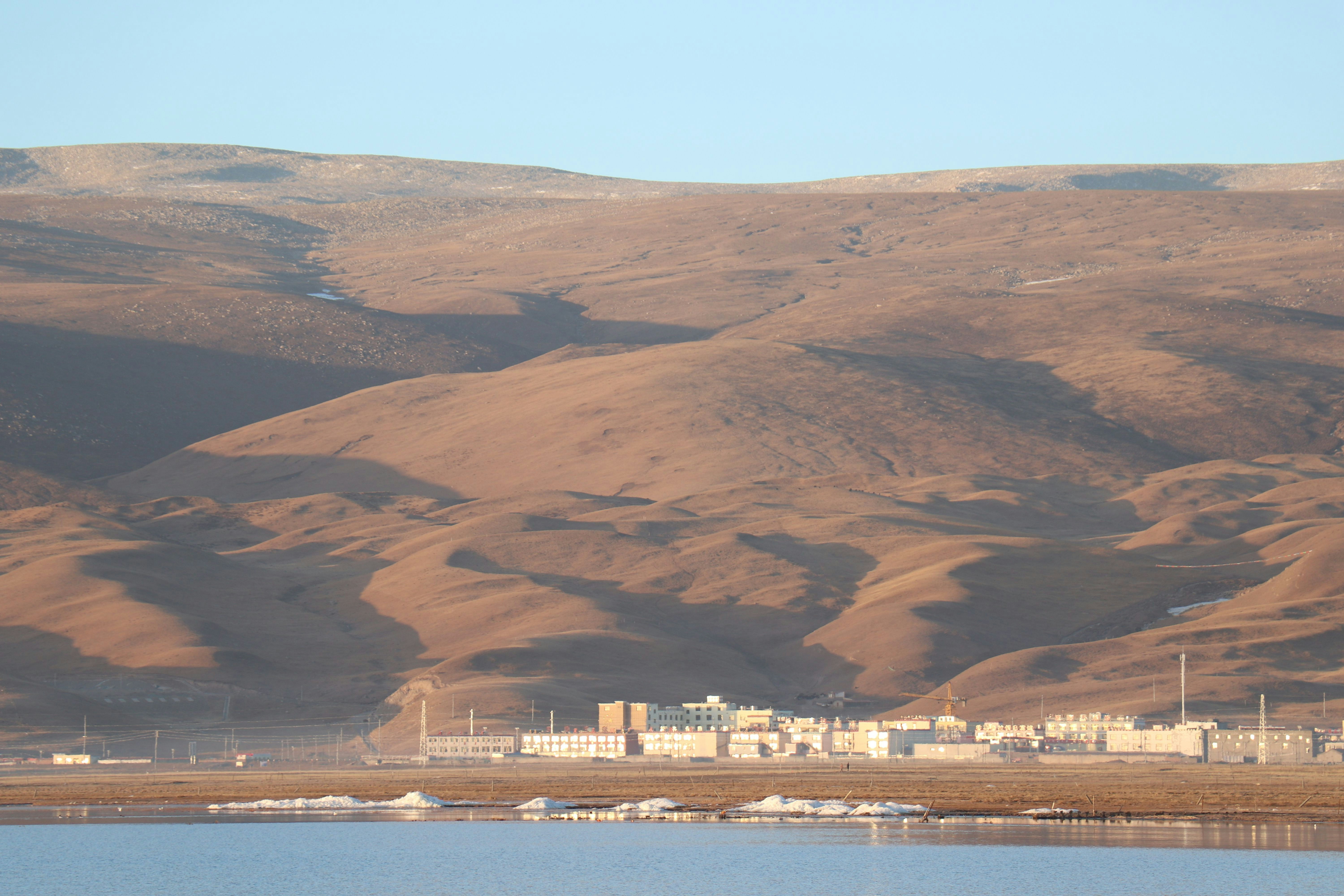 Brown mountain near body of water during daytime photo – Free Qinghaihu ...