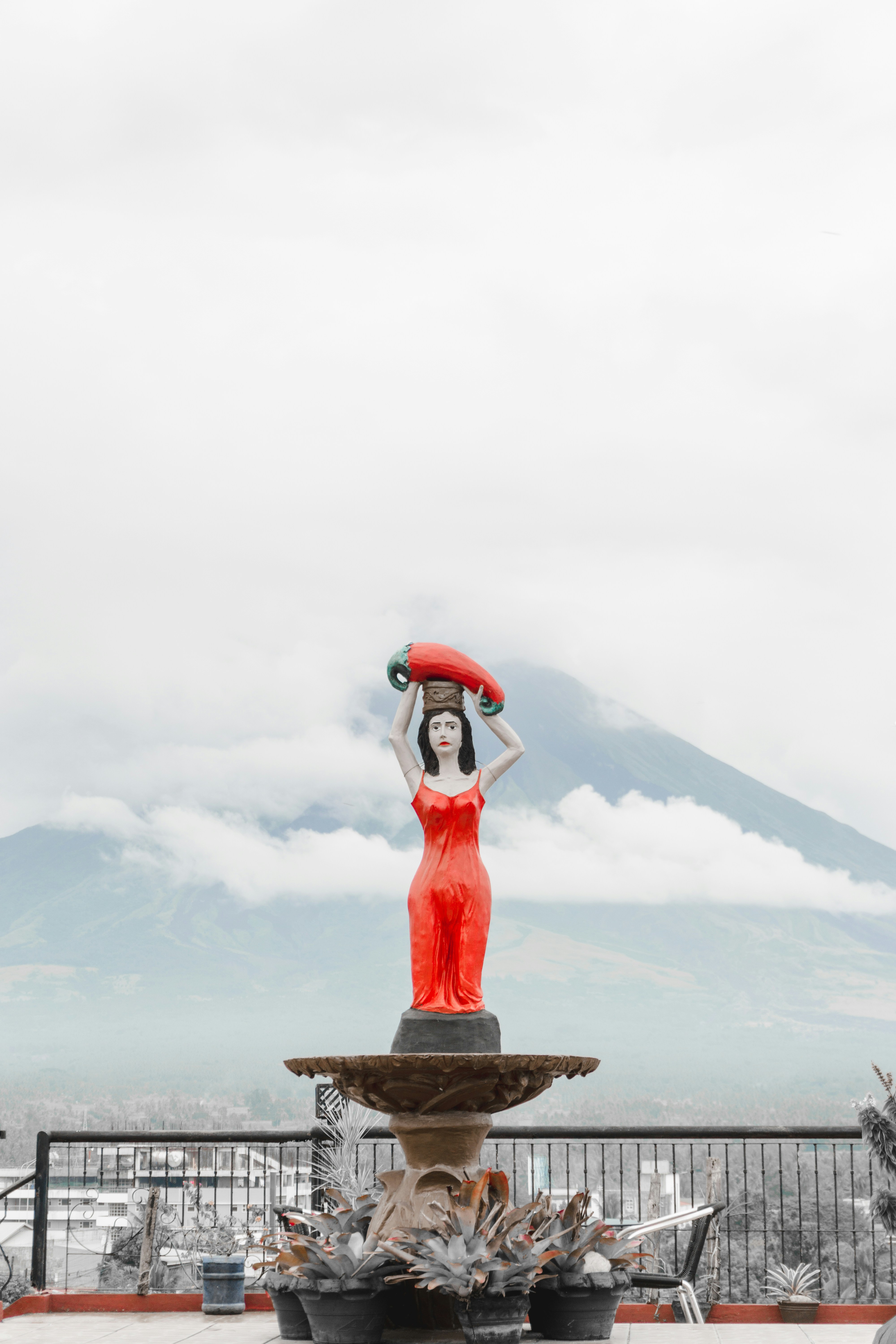Crimson Figure on a Terrace Framed by Mount Fuji's Mist