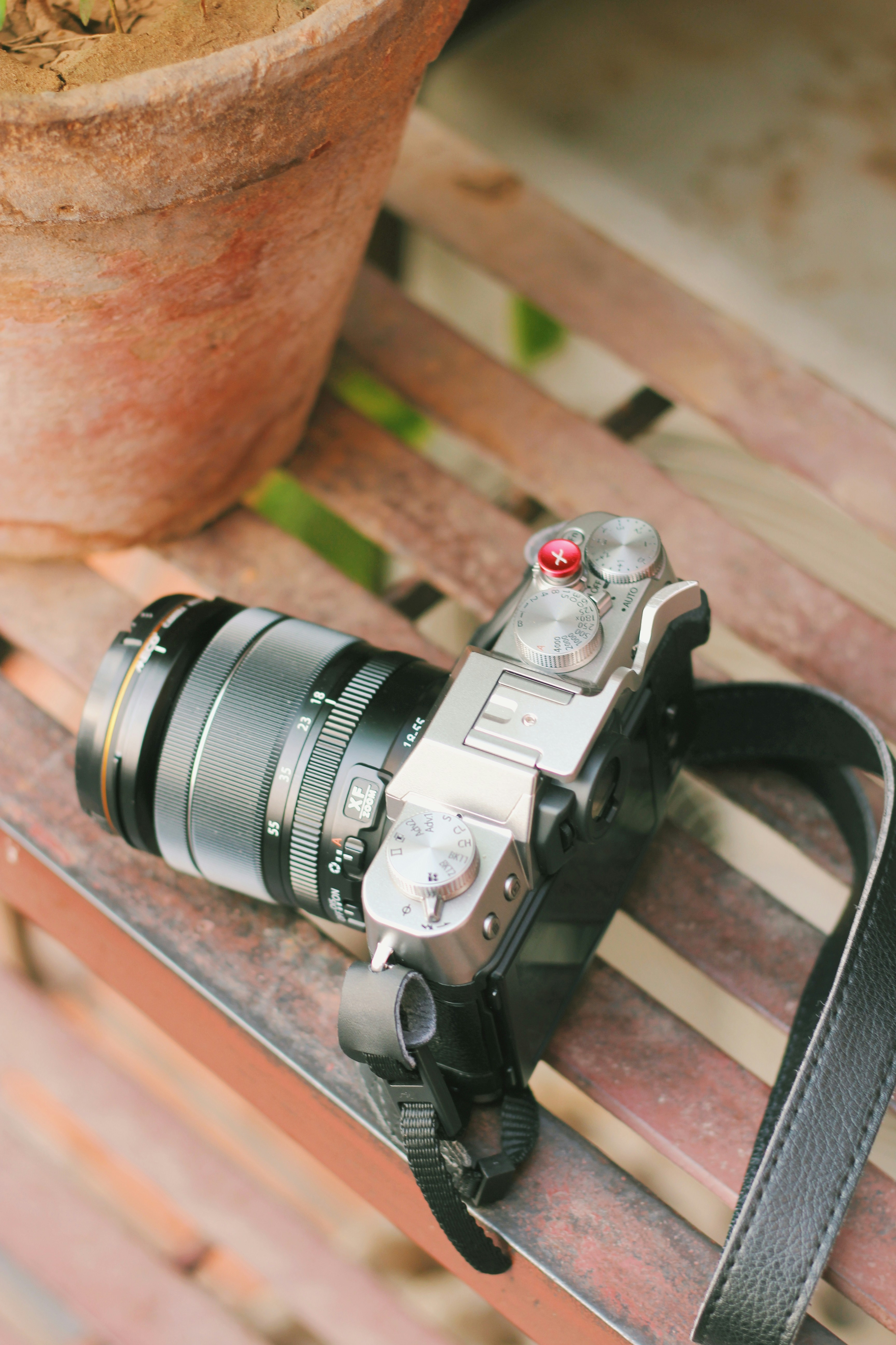 Retro Lens, Modern Moment: A Silver Canon on a Weathered Bench