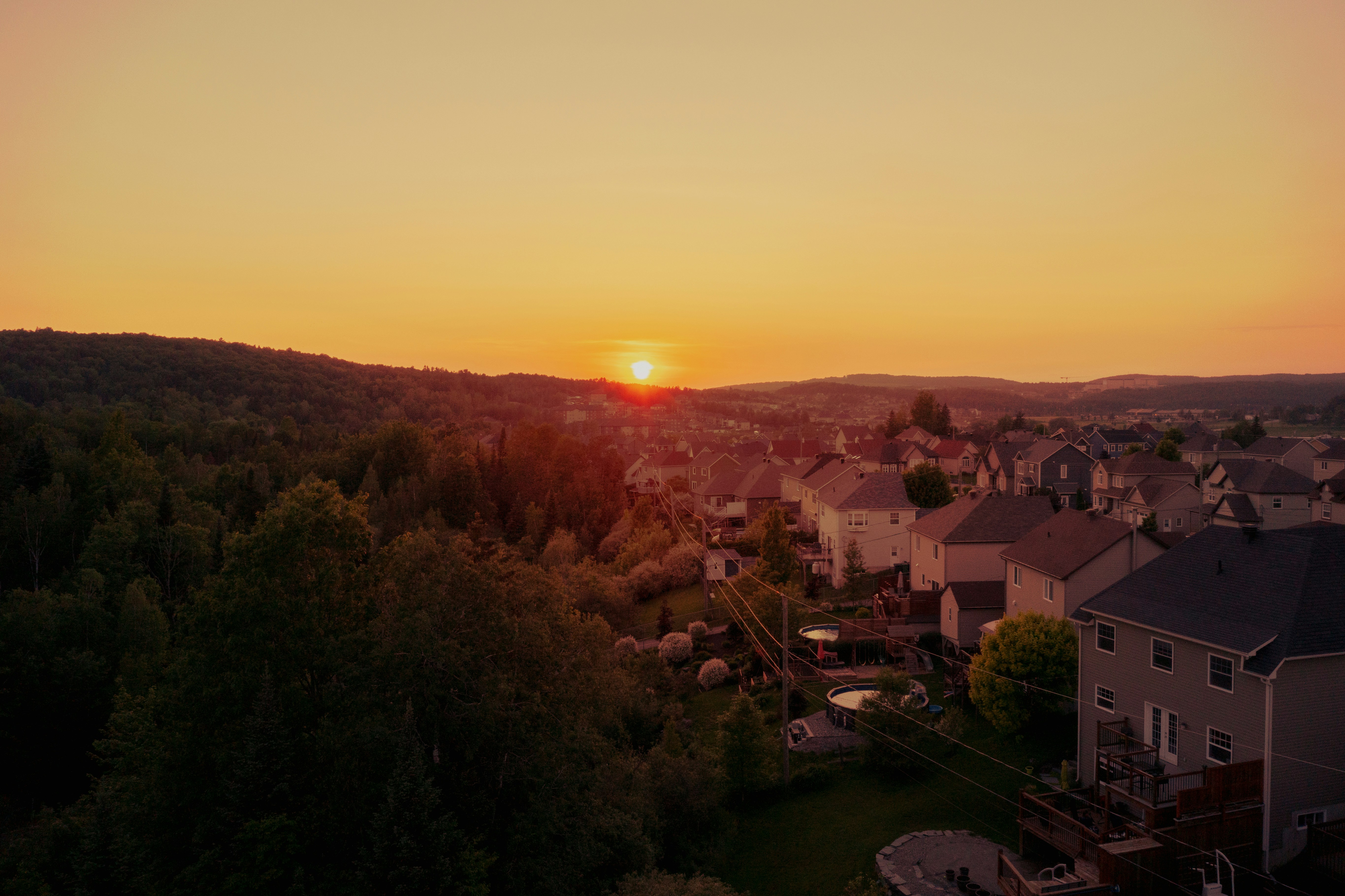 Sunset Over a Leafy Suburb: Aerial Quiet at Dusk