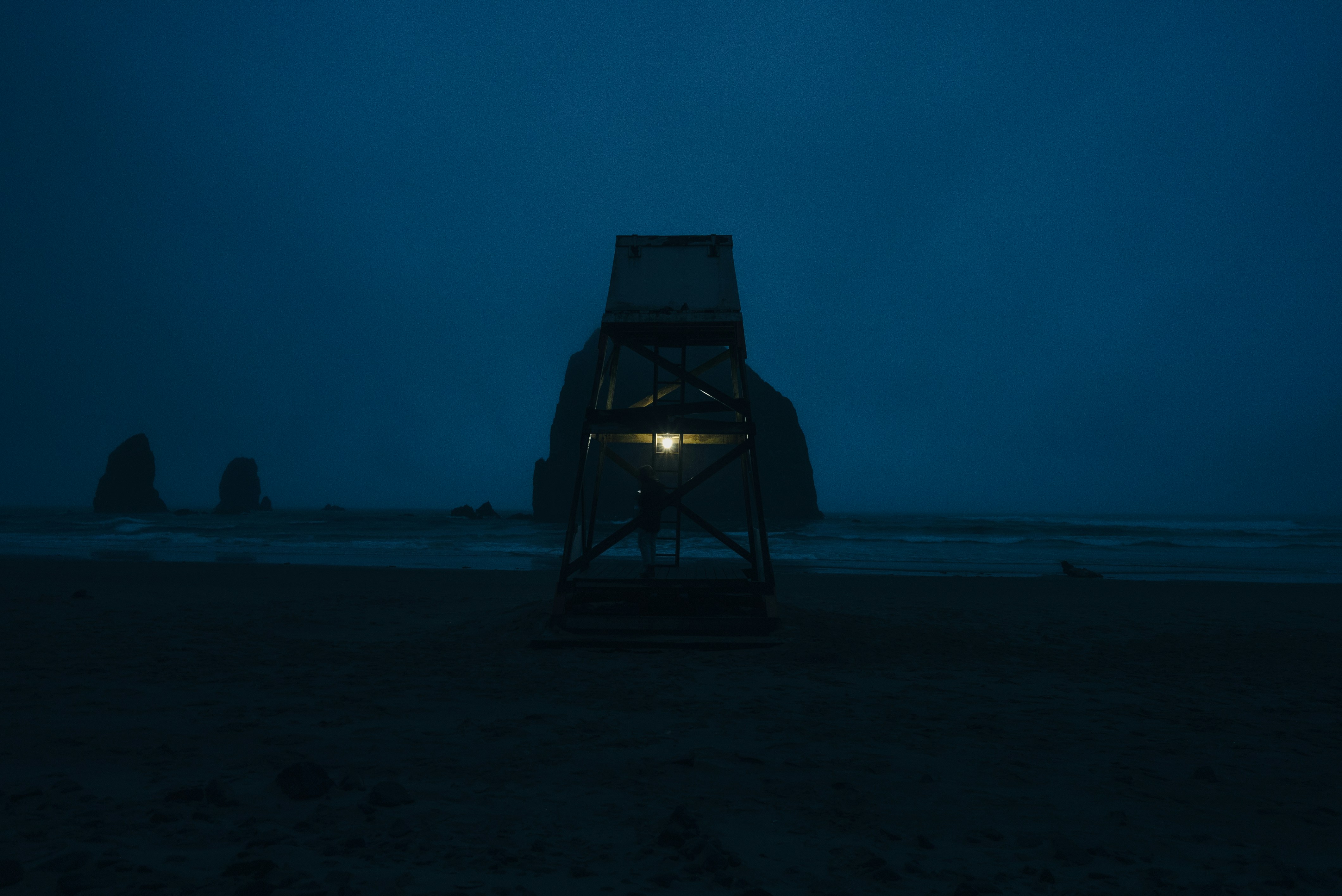 Blue Hour Beacon: Lone Lifeguard Tower on a Quiet, Misty Shore