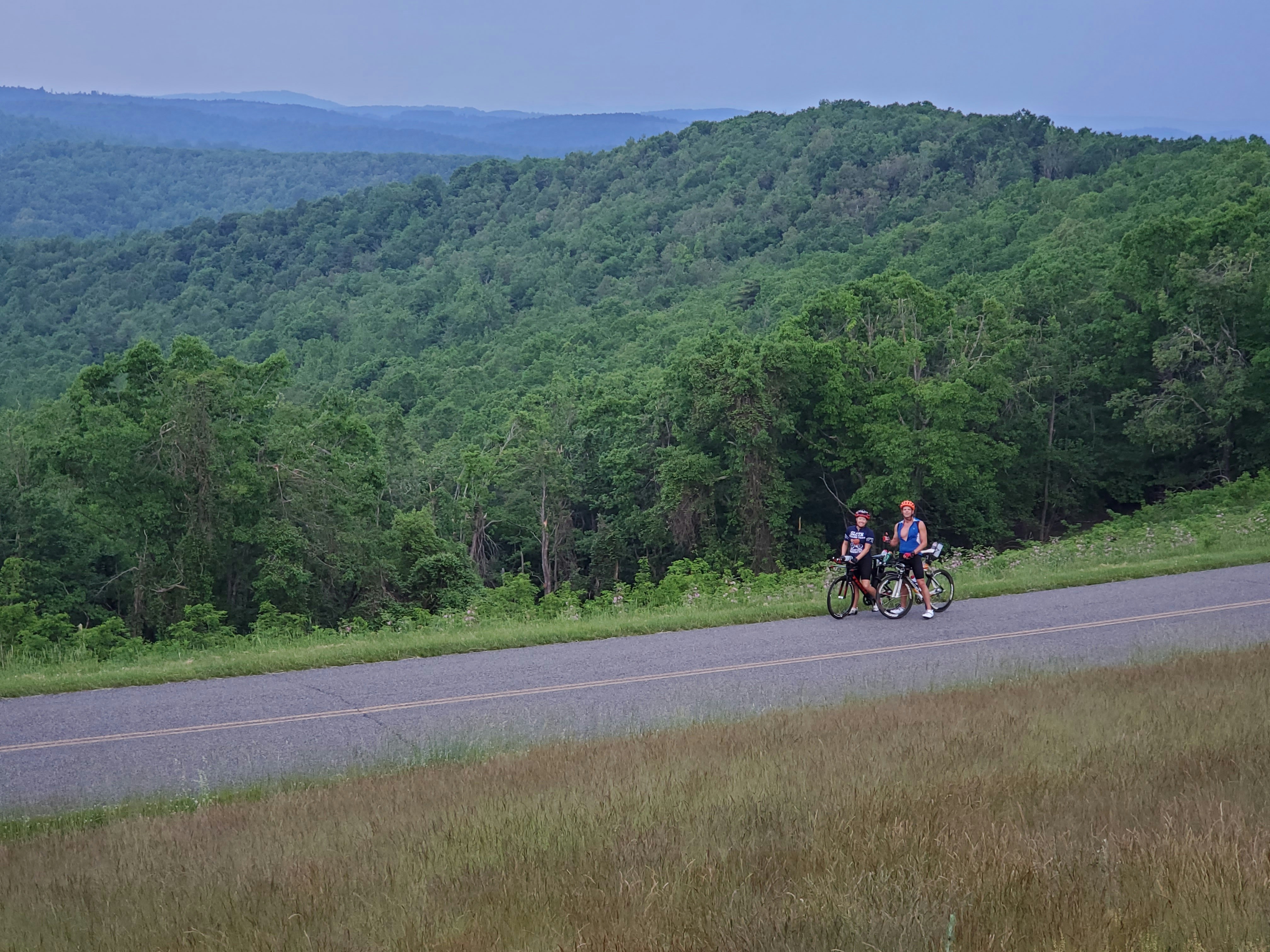 Ridge Road Encounter: Cyclists on a Green Plateau