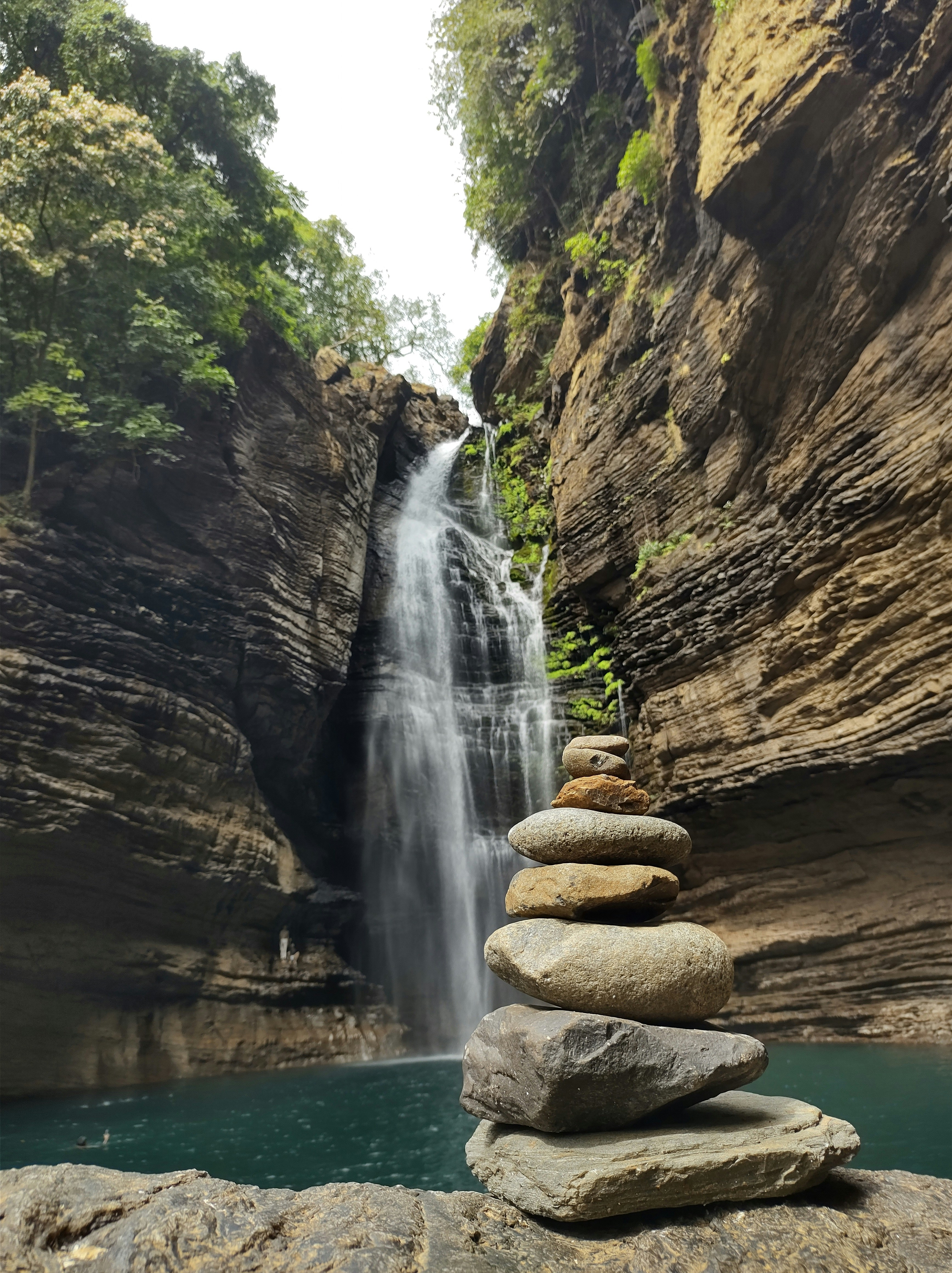Waterfalls in between brown rock formation during daytime photo – Free ...