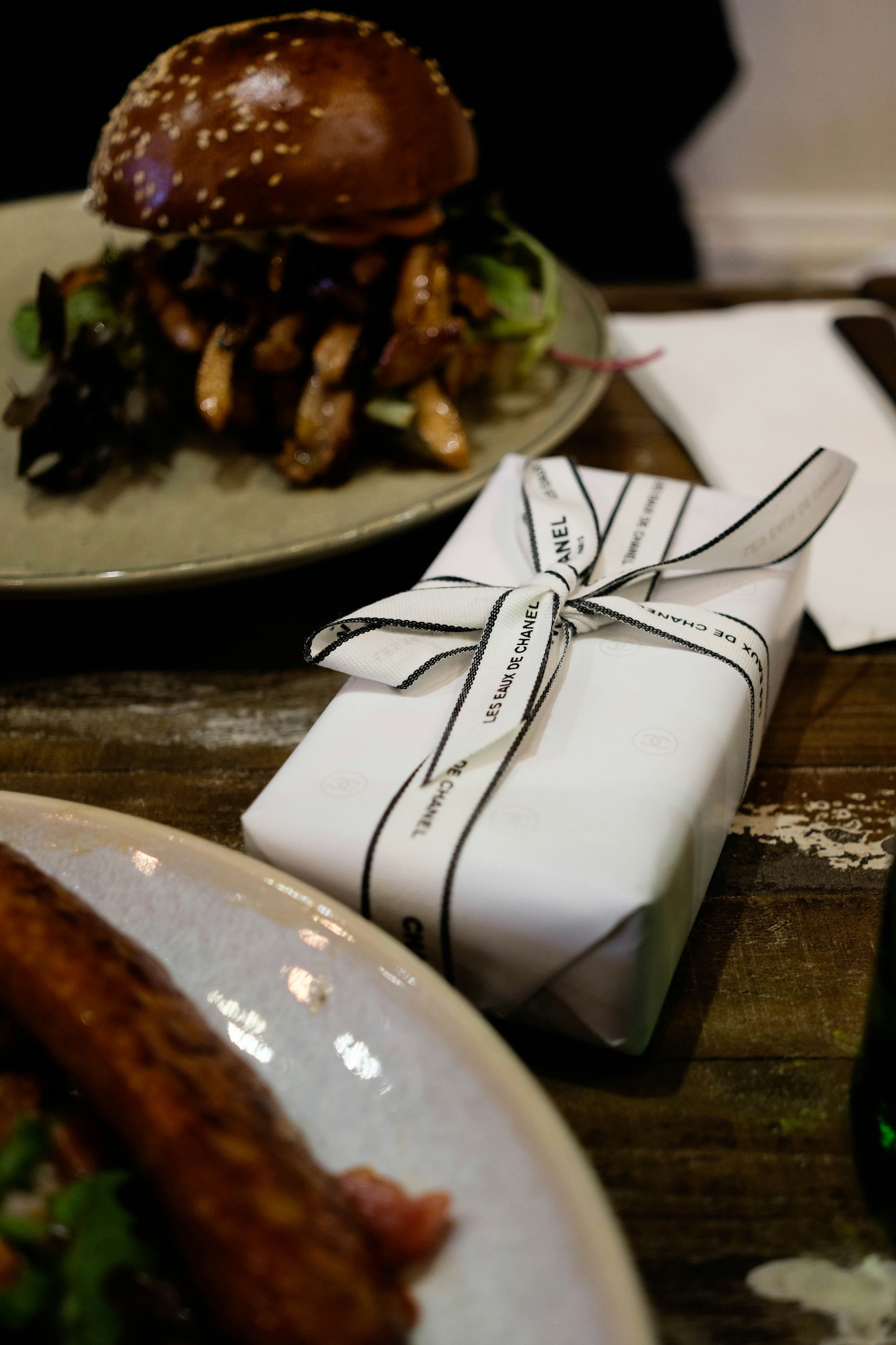 Chanel Ribbon Gift Box Anchors a Burger-Plate Table