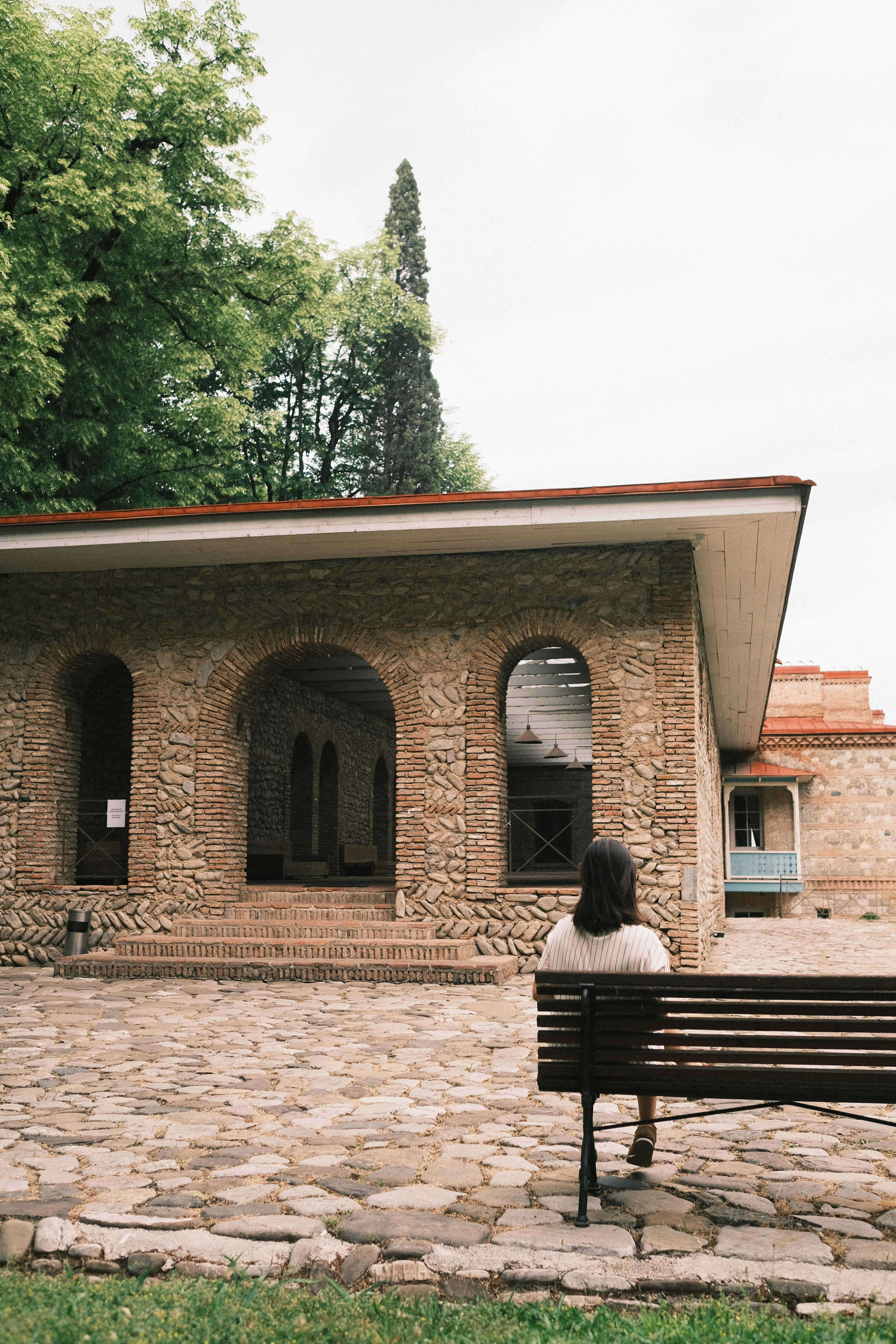 Bench by the Arches: A Quiet Moment in a Stone Courtyard