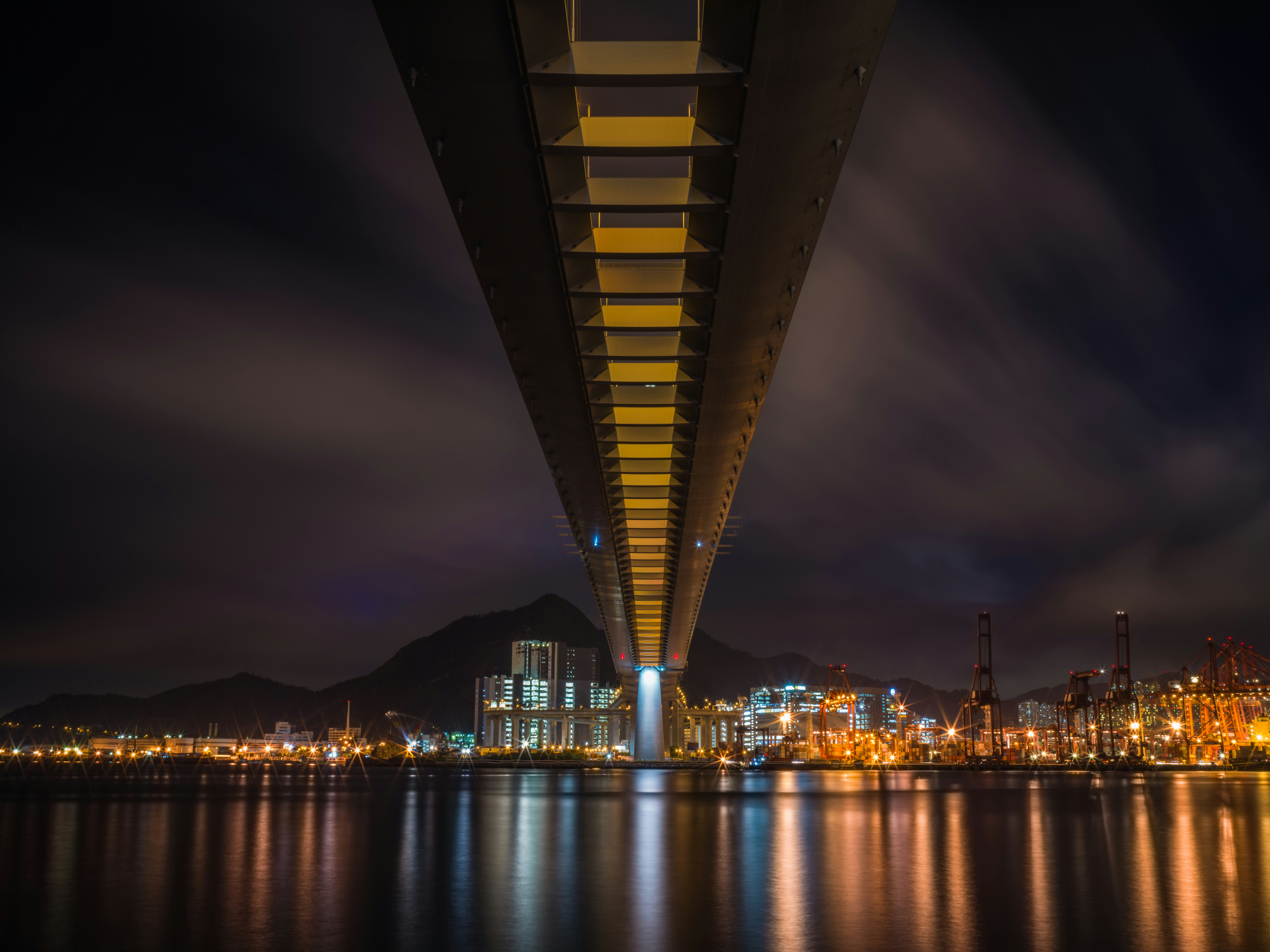 Under the Harbor Arch: Neon Reflections on Night-Water