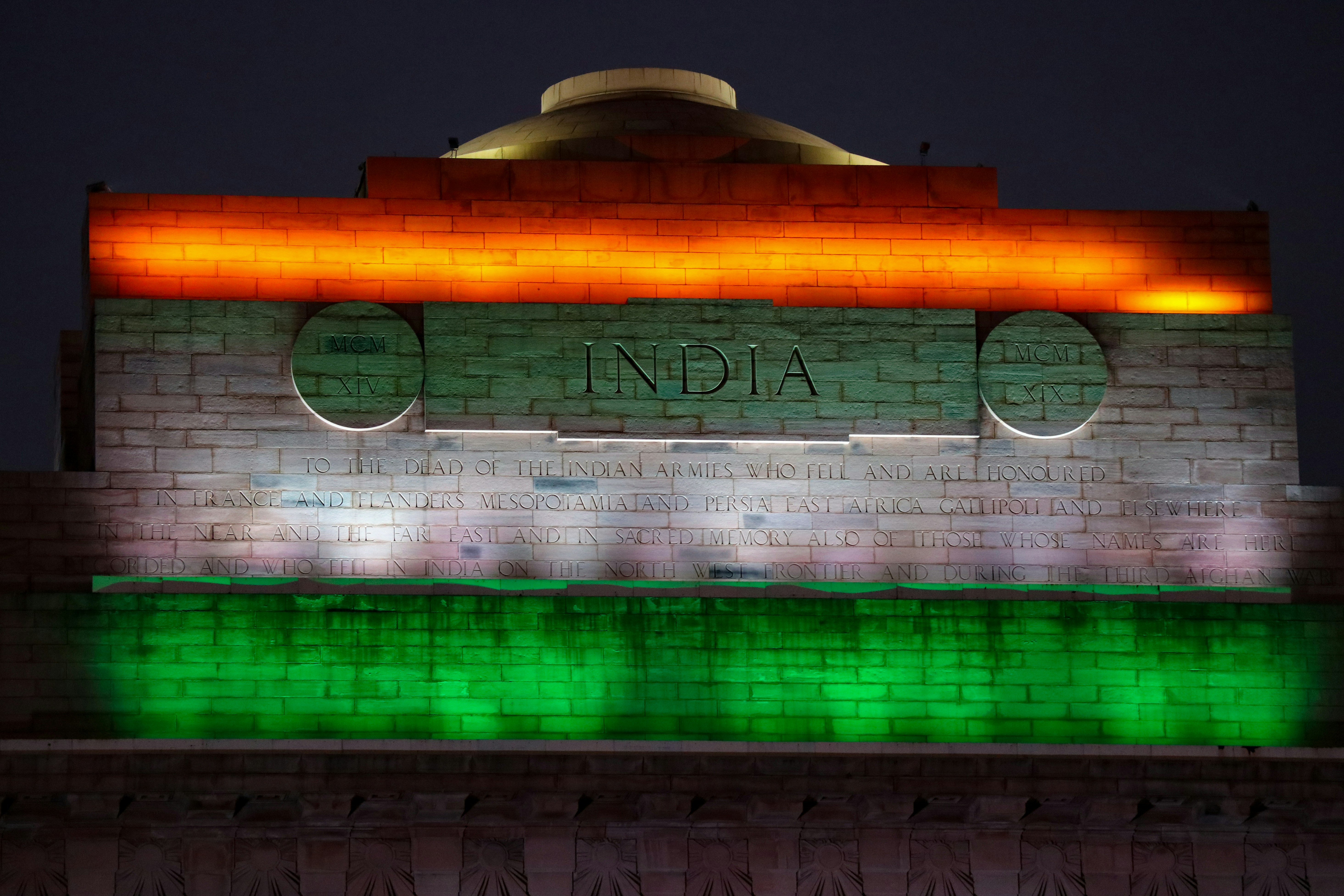 A brick building with a lit up sign on top of it photo – Free India ...