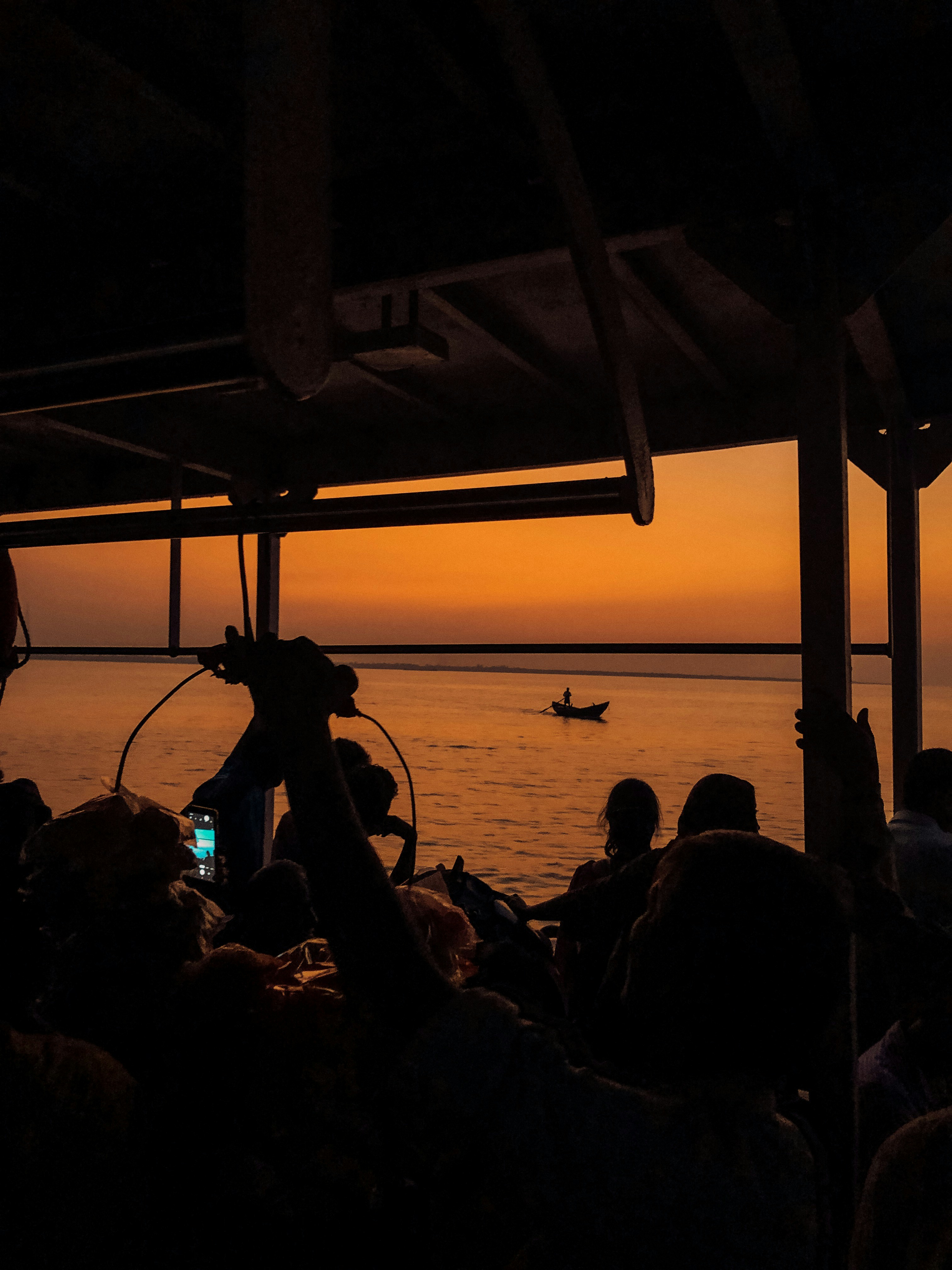 A group of people watching a boat go by photo – Free India Image on ...