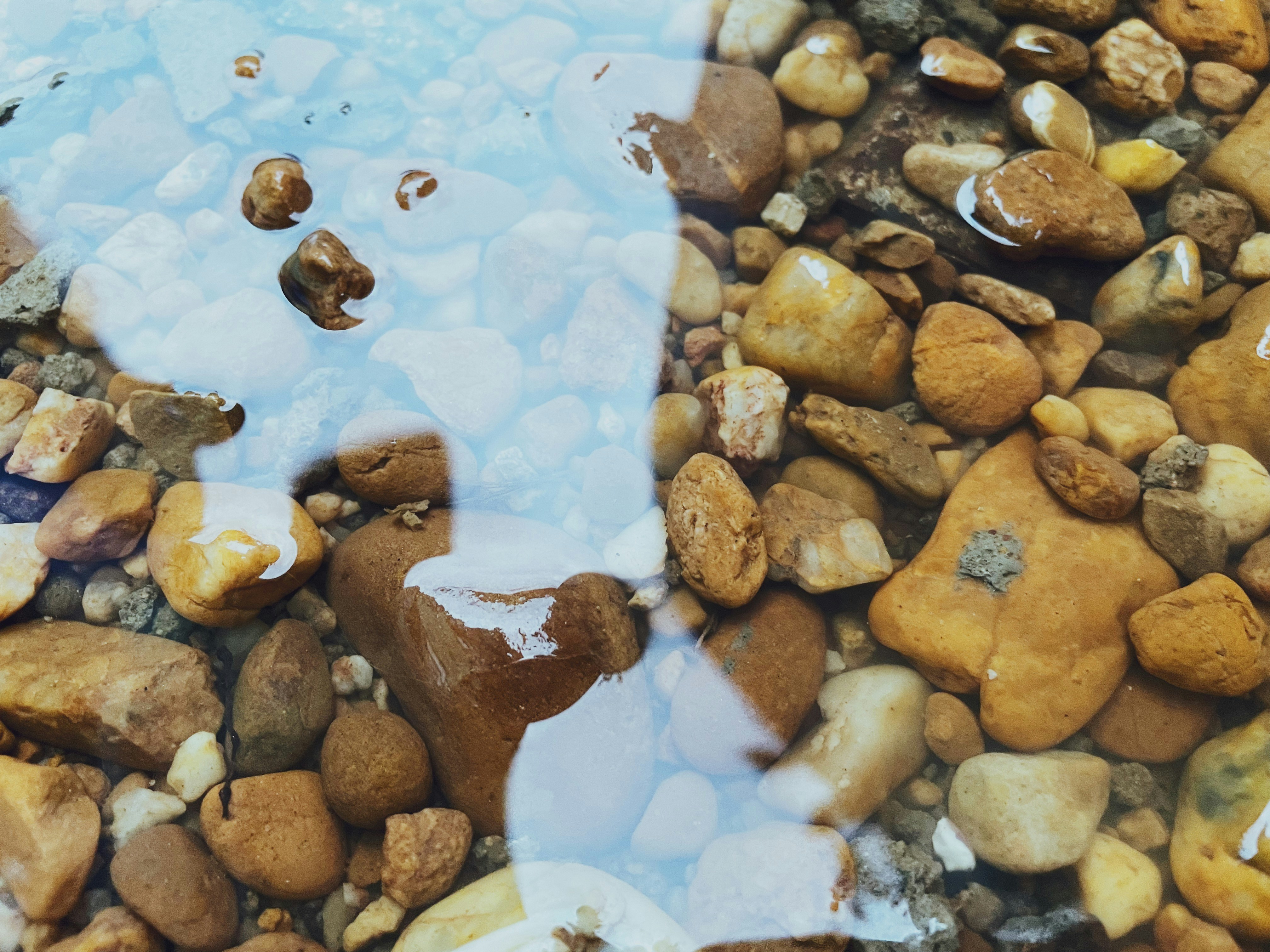 Blue Wash Across a Pebble Riverbed