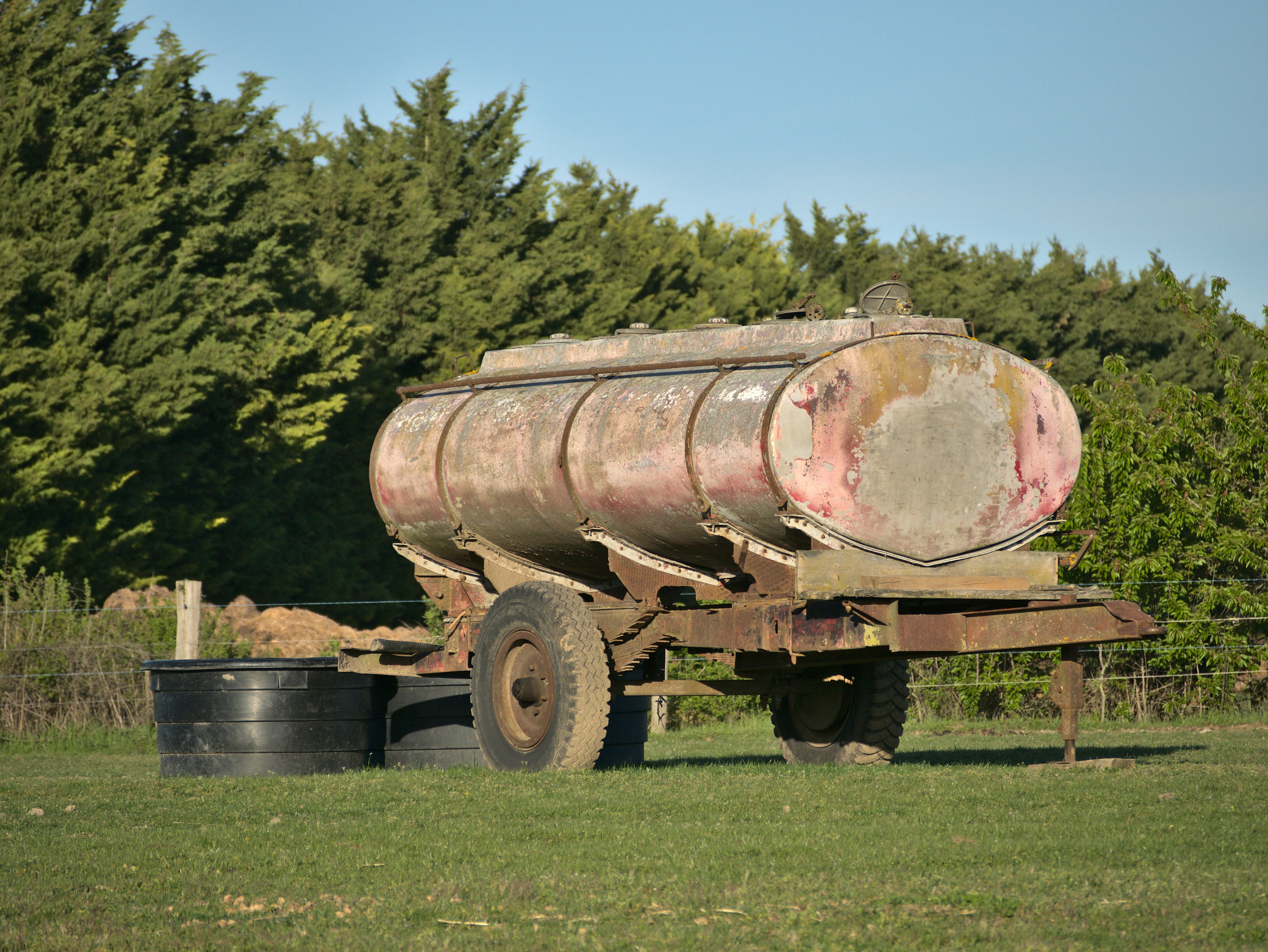 An old rusty tanker truck parked in a field photo – Free Field Image on ...