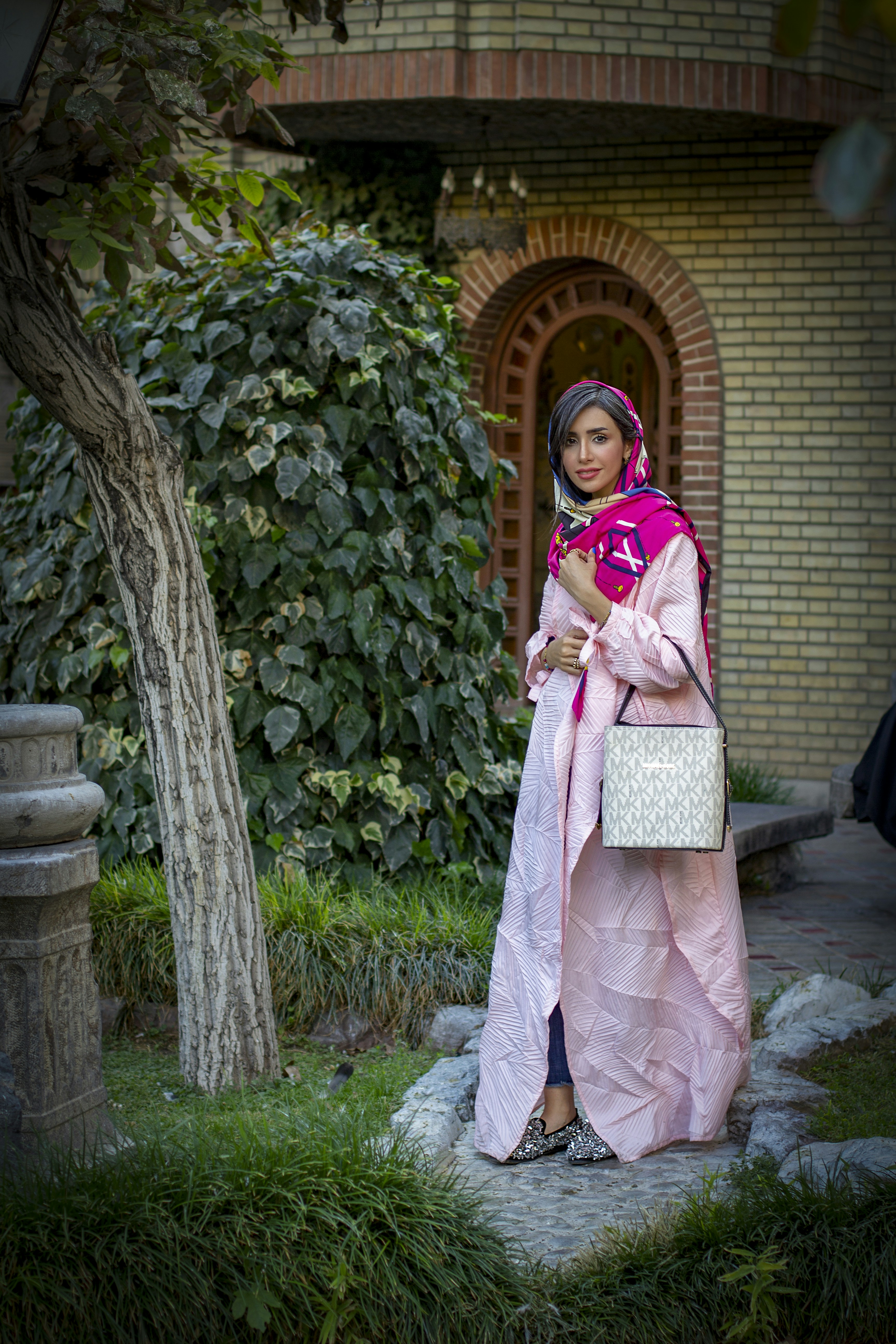A woman in a pink dress holding a white purse photo – Free Human Image ...