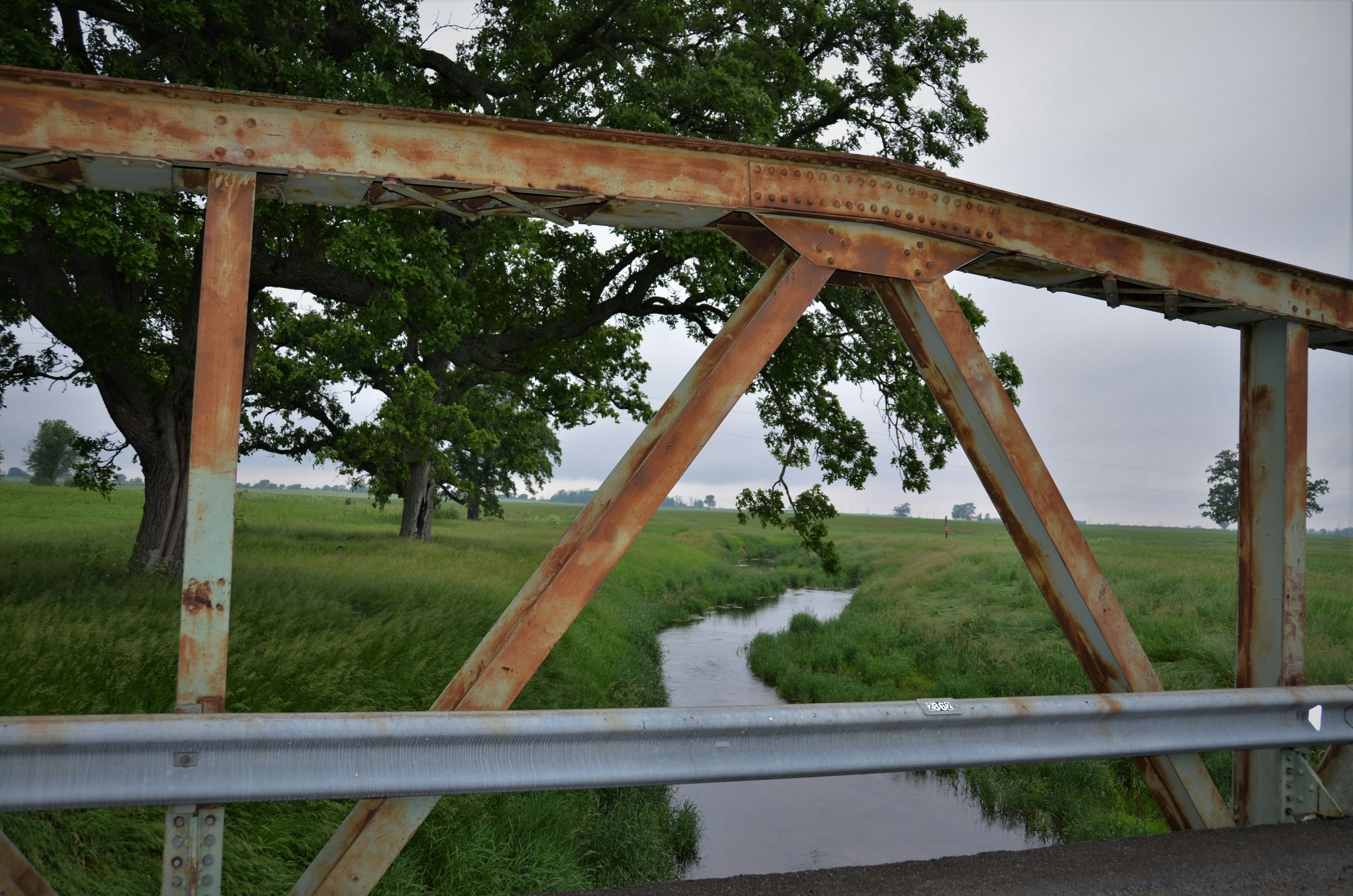 Rusted Triangles Over a Quiet River Span