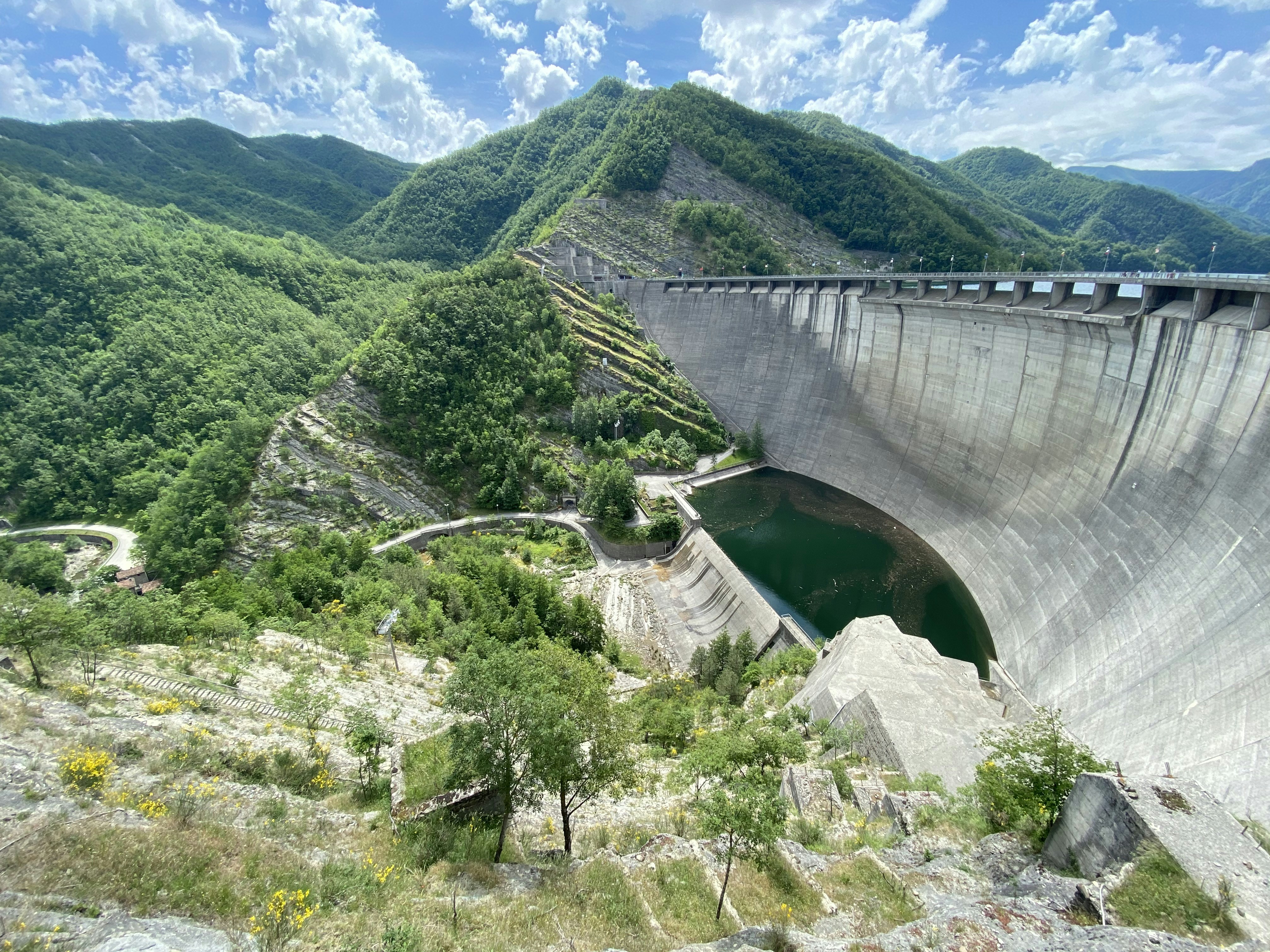 A view of a dam in the middle of a mountain range photo – Free Building ...