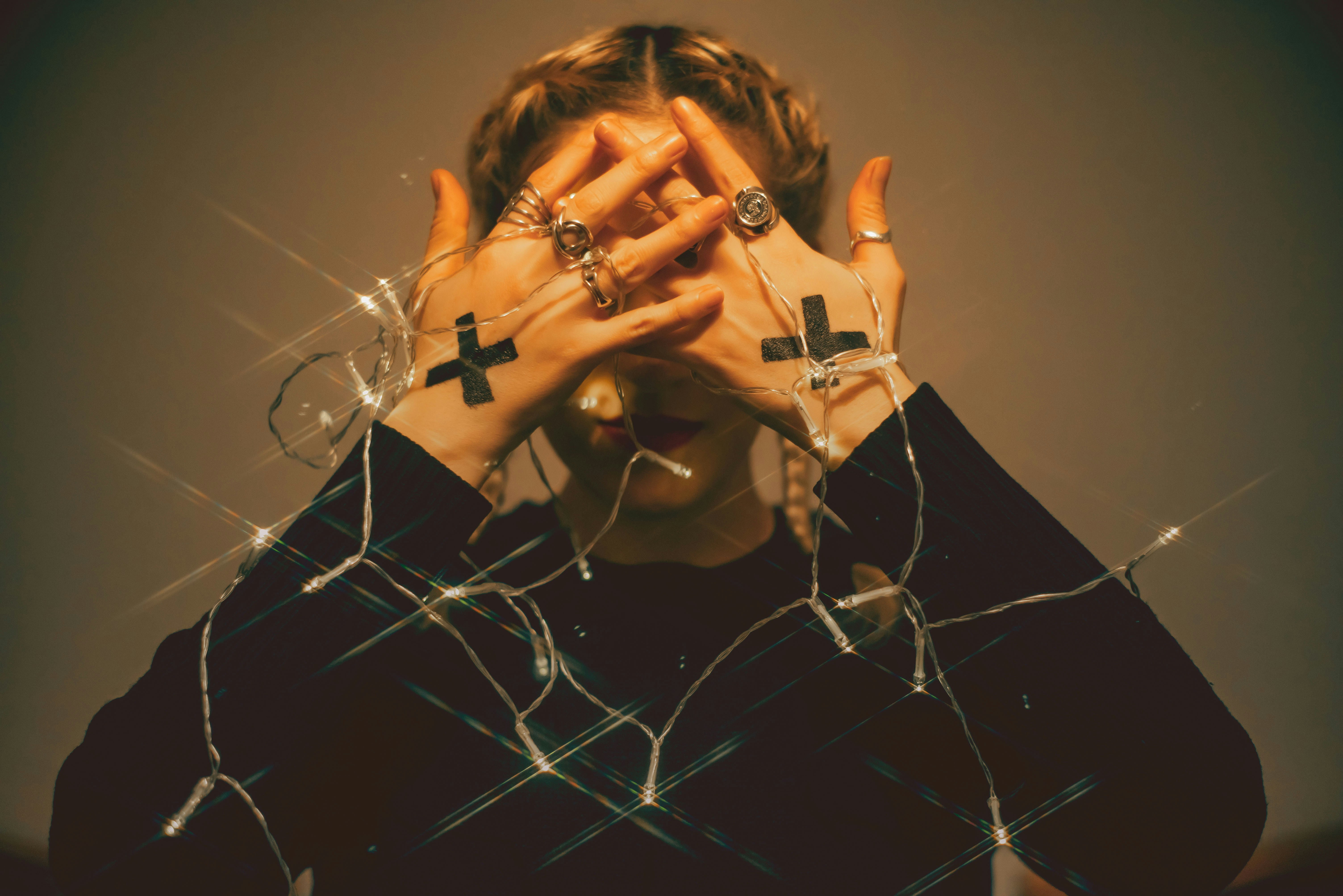 A woman covering her face with her hands photo – Free Lights Image on ...