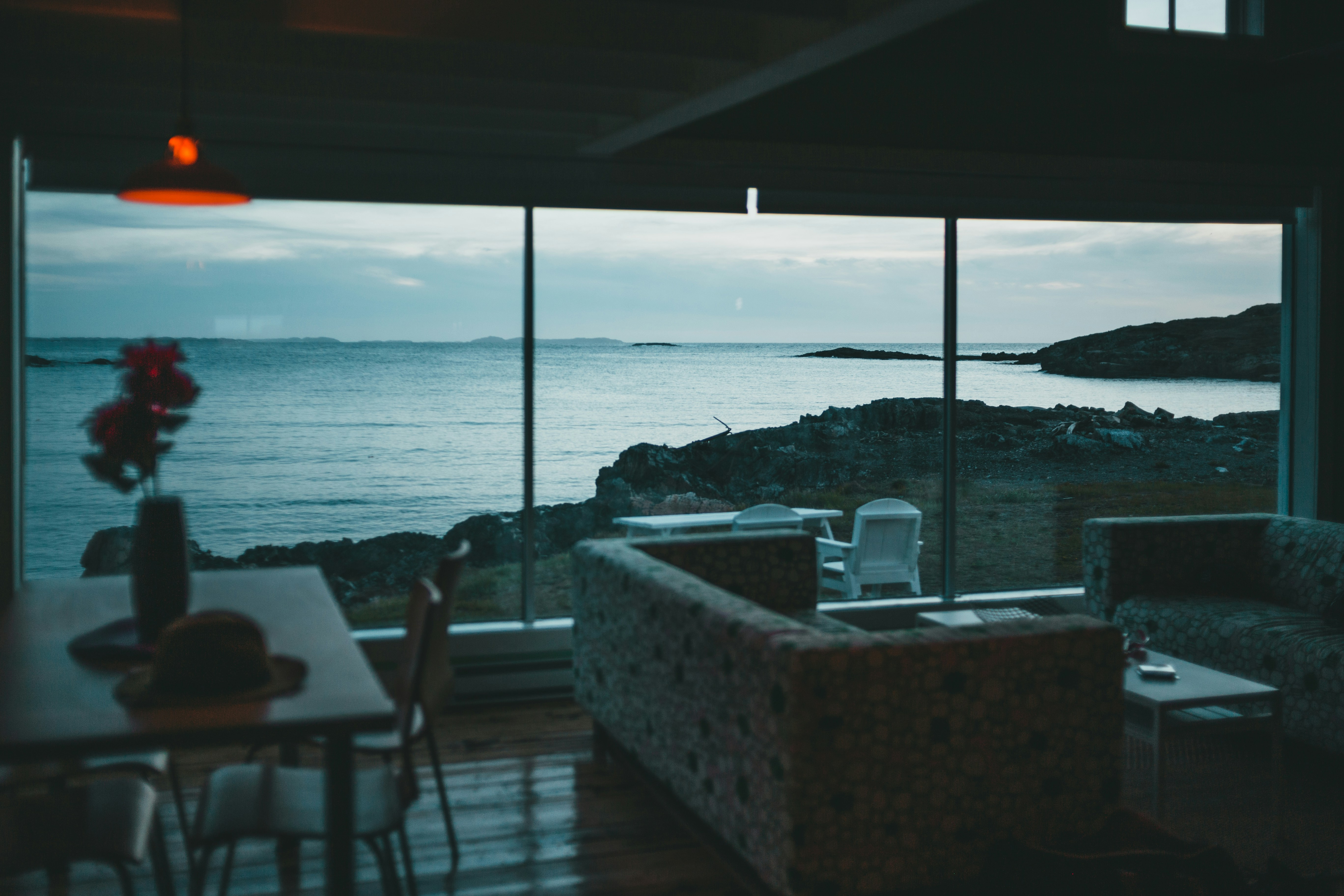 white table and chairs near body of water during daytime