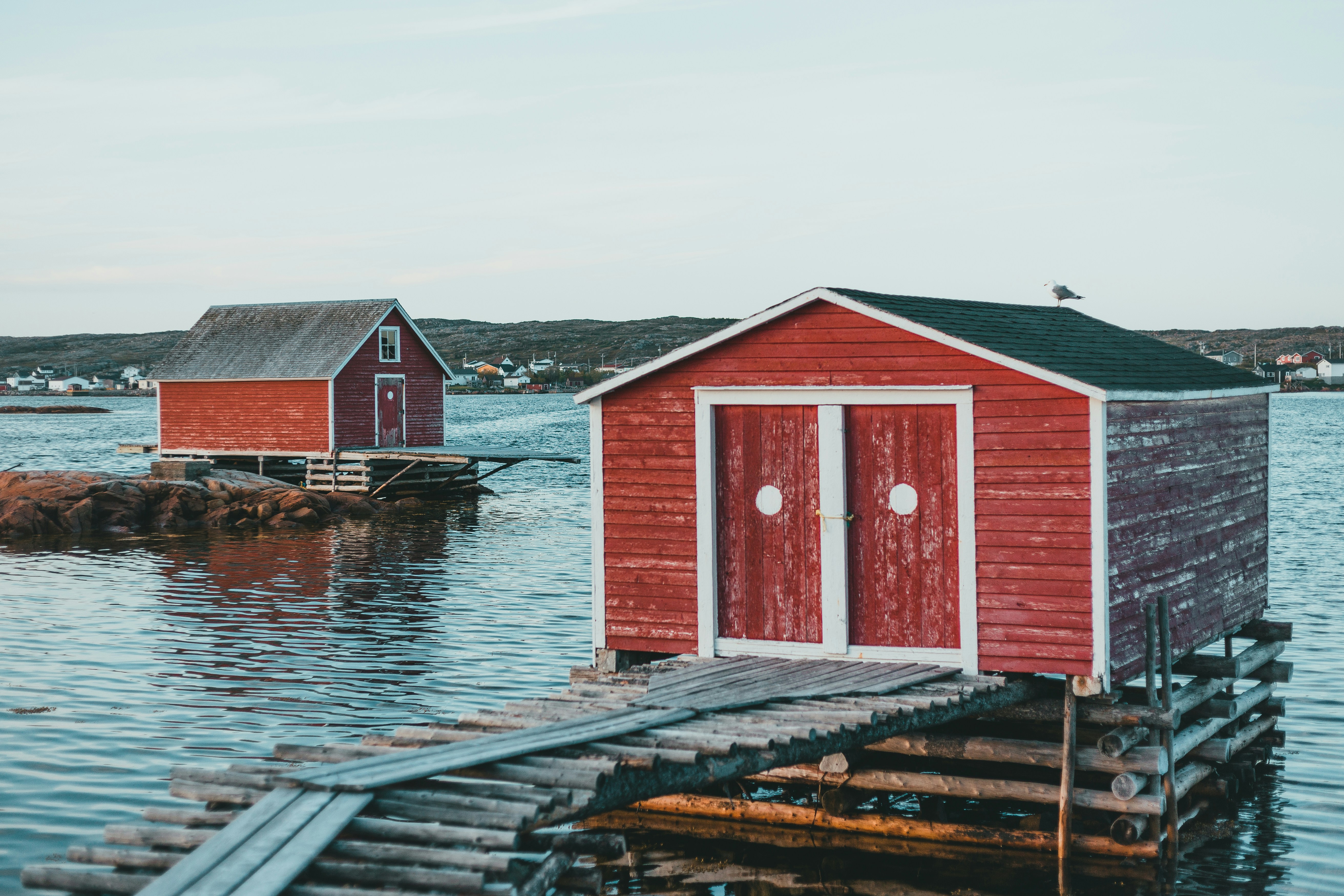 A red boathouse sitting on top of a body of water photo – Free Housing ...