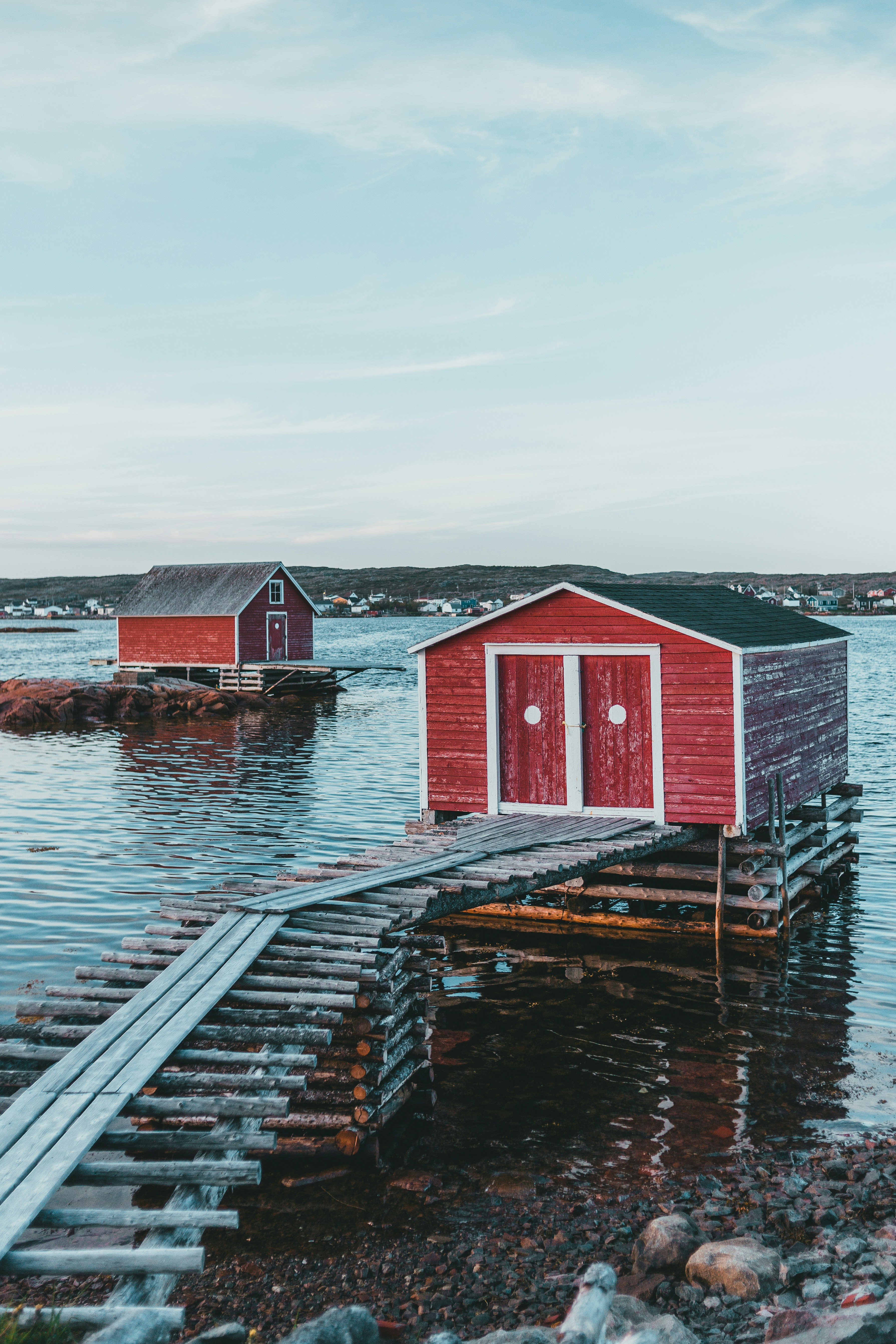 A red boathouse sitting on top of a body of water photo – Free Building ...