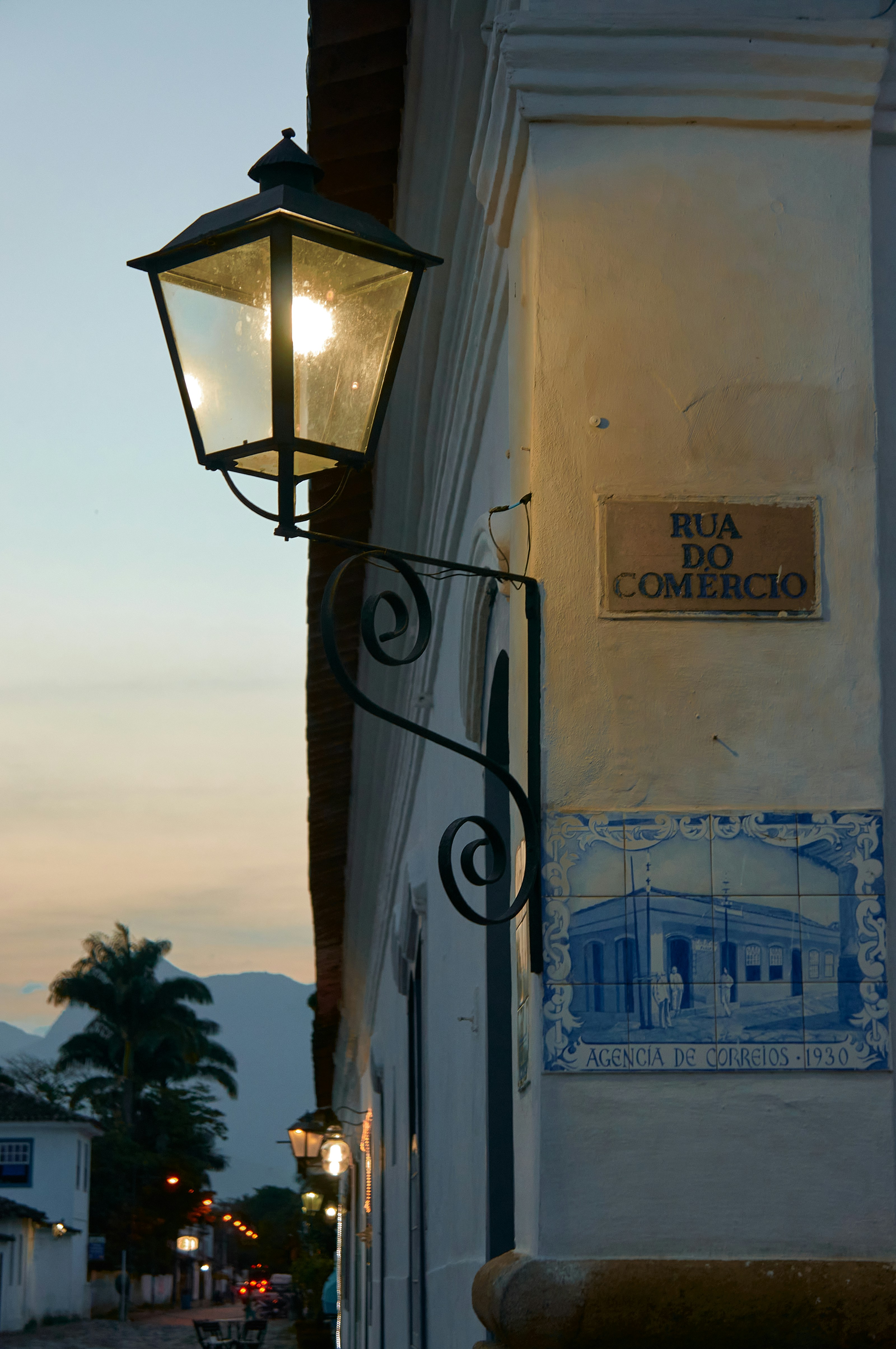 Gaslamp at Dusk on Rua do Comércio: Azulejo Tile Meets Warm Glow