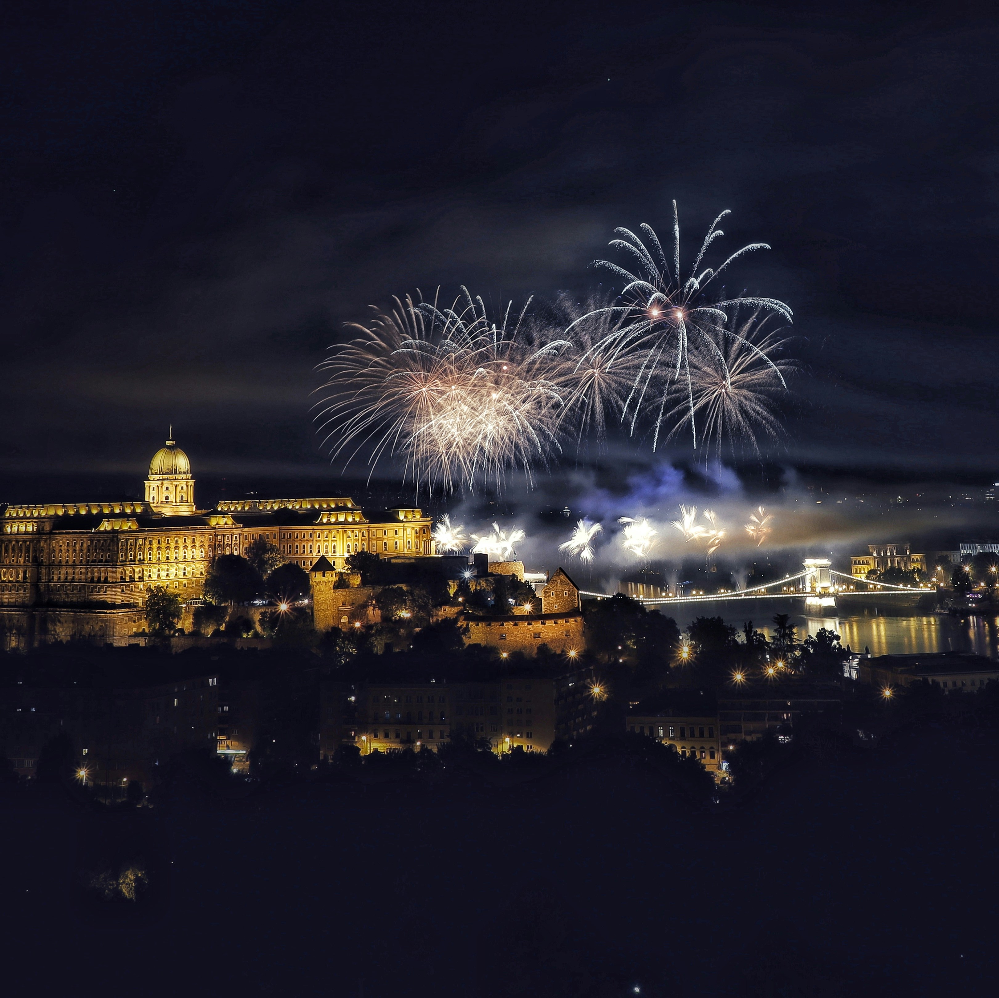 Fireworks are lit up the night sky over a city photo – Free Budapest ...