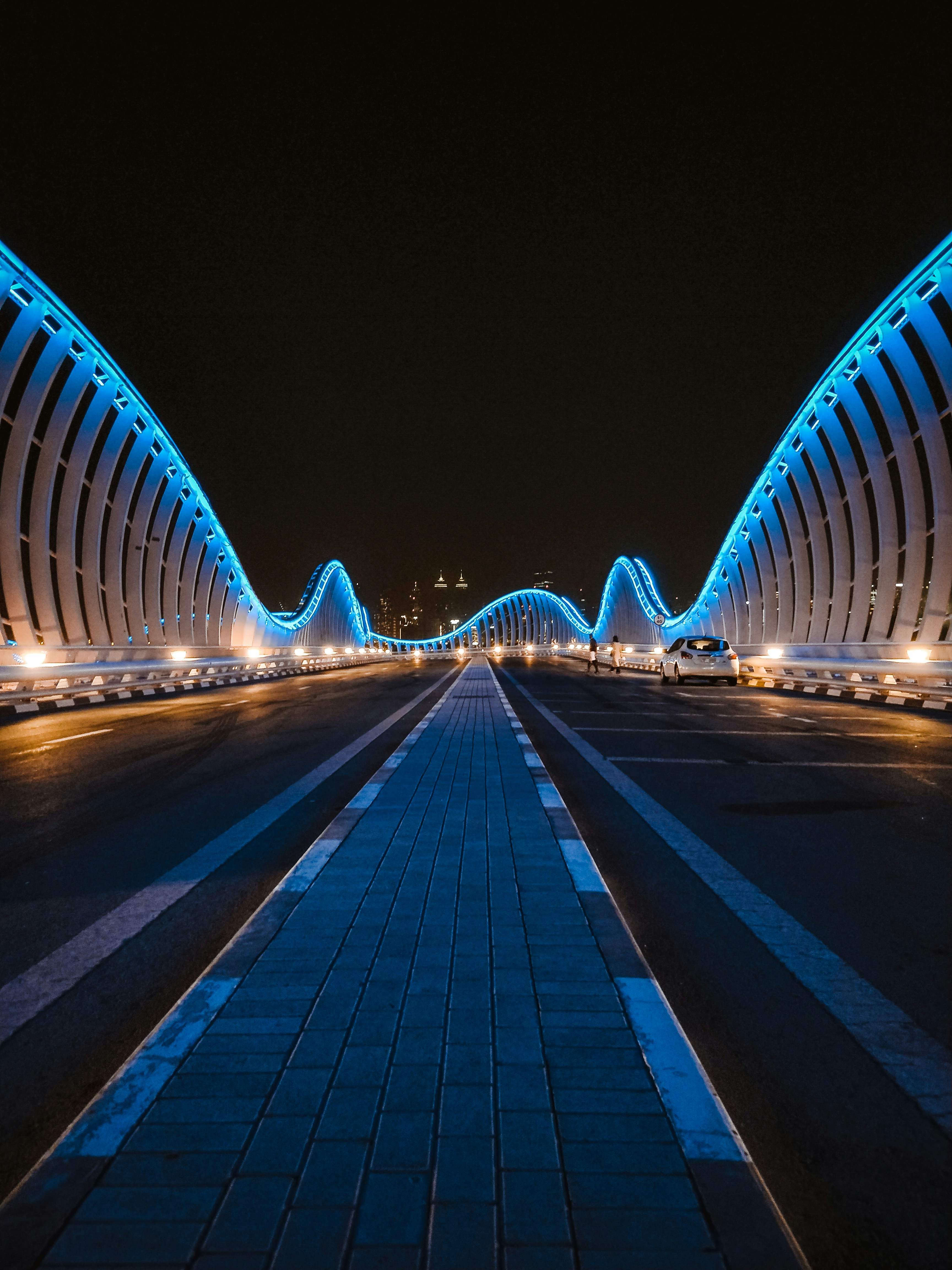A very long bridge that is lit up at night photo – Free Meydan bridge ...
