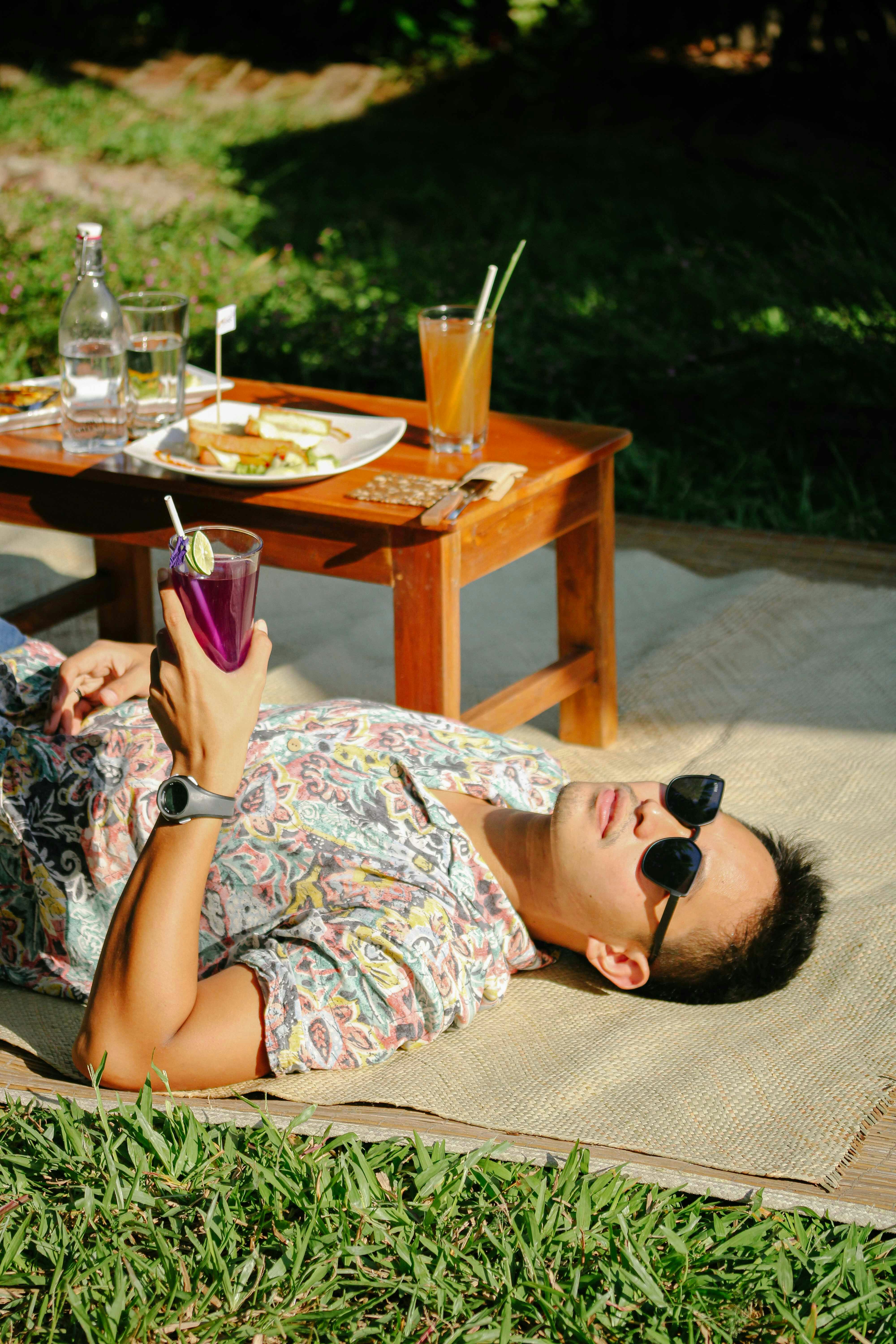 Sunlit Siesta with a Violet Cocktail by the Wooden Patio Table