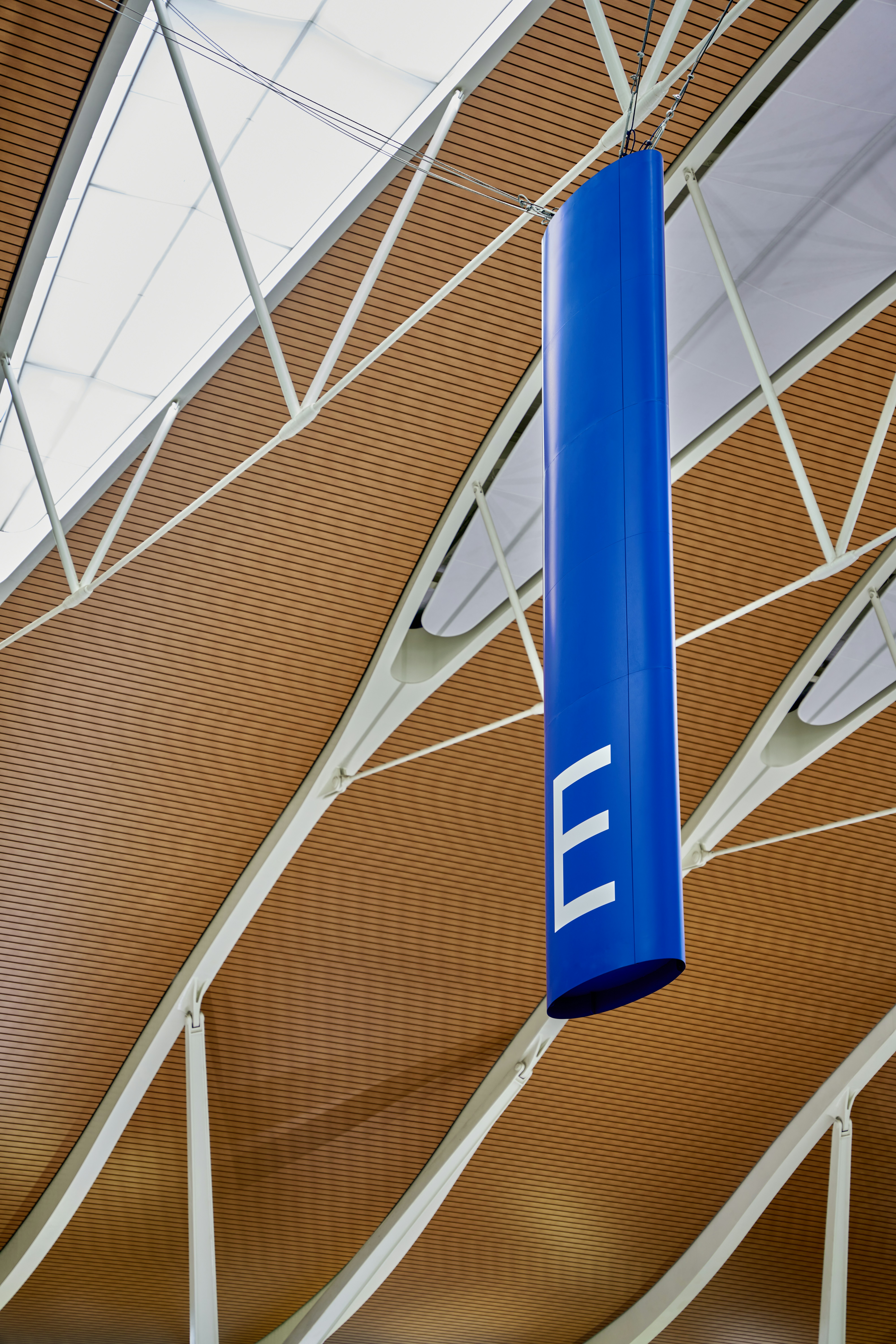 A blue sign hanging from the ceiling of a building photo – Free ...