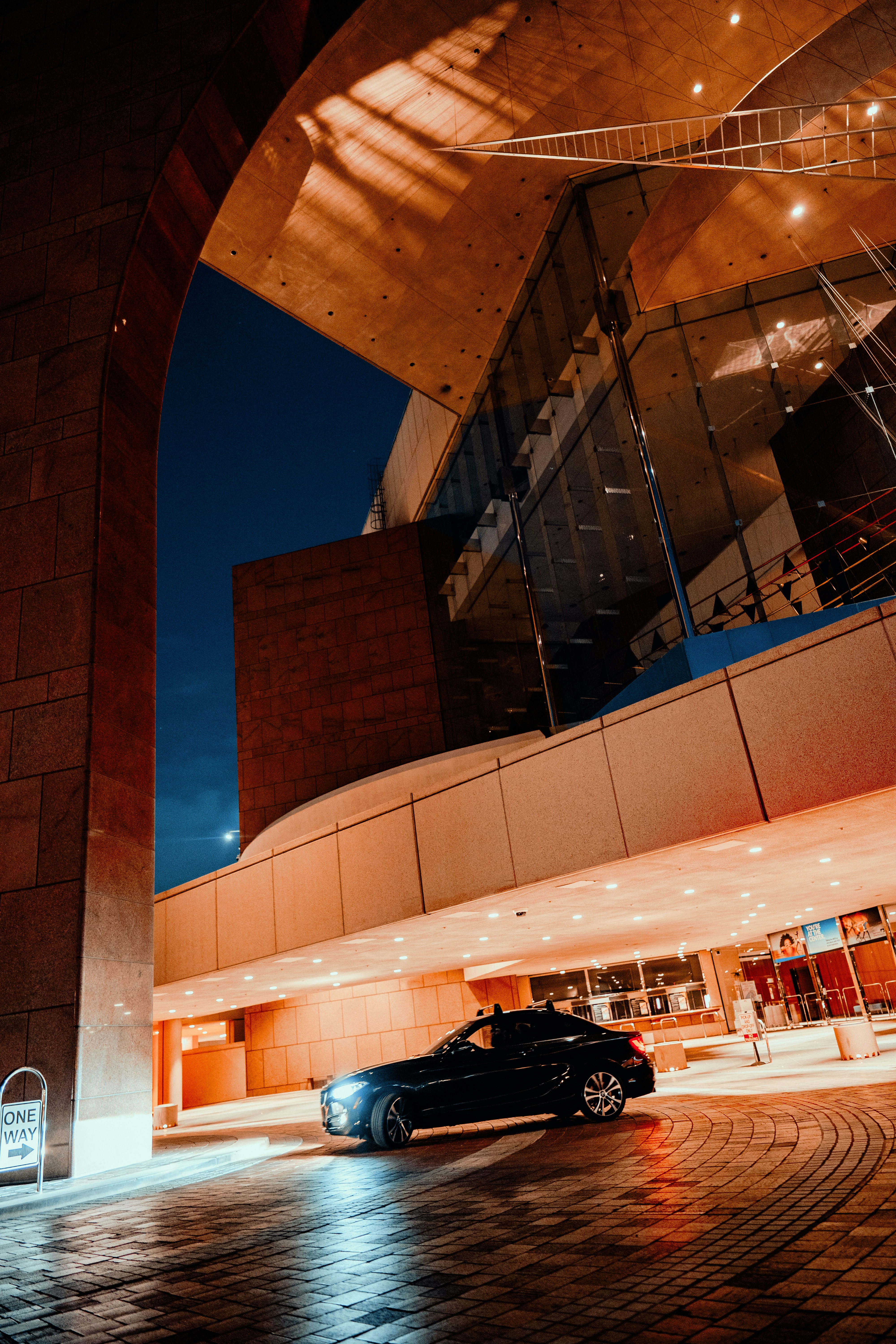 Under the Arch: Night Drive Beneath Modern Geometry