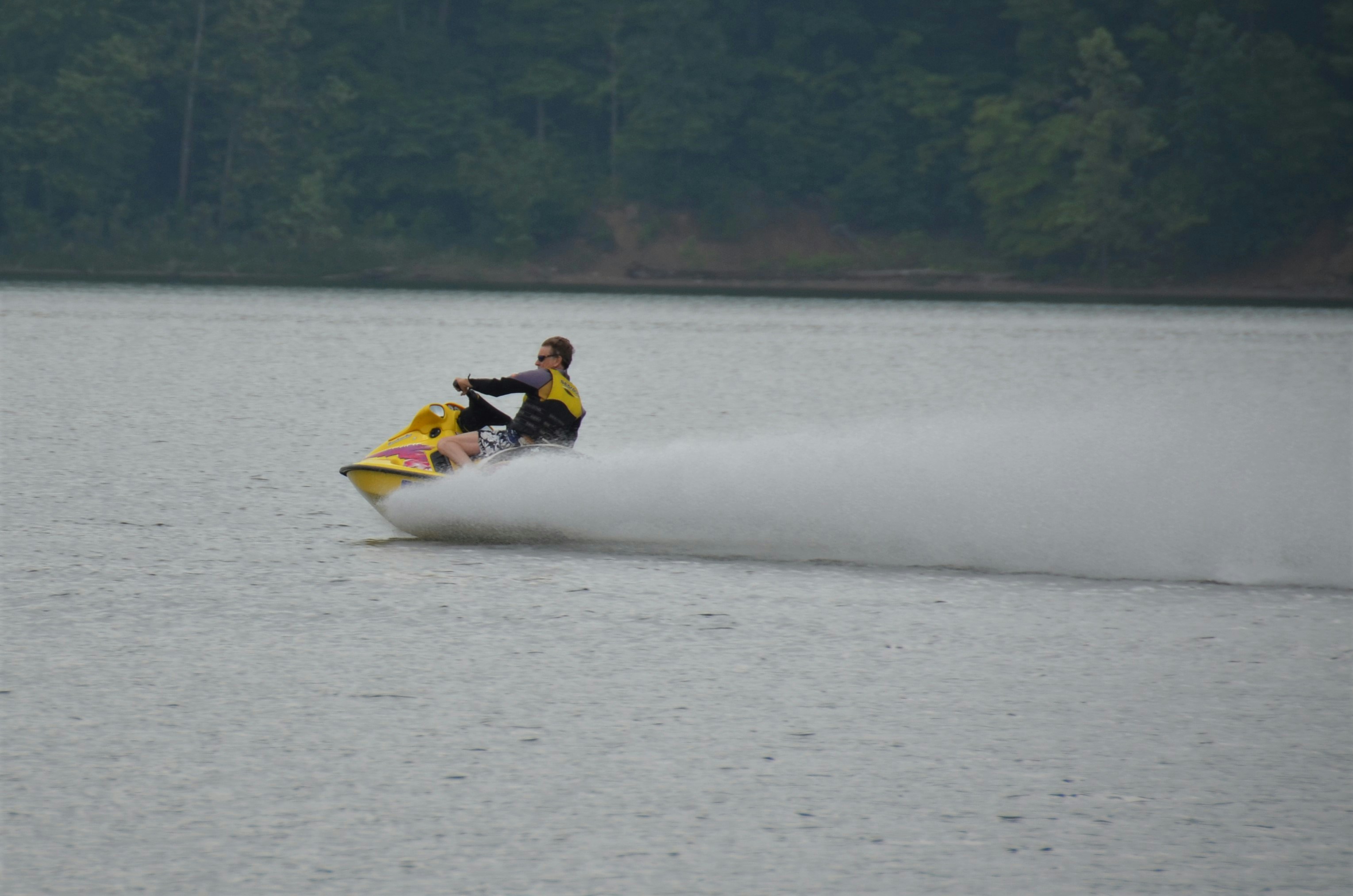 Yellow Jet Ski Sprint Carves a White Wake Across a Silent Lake