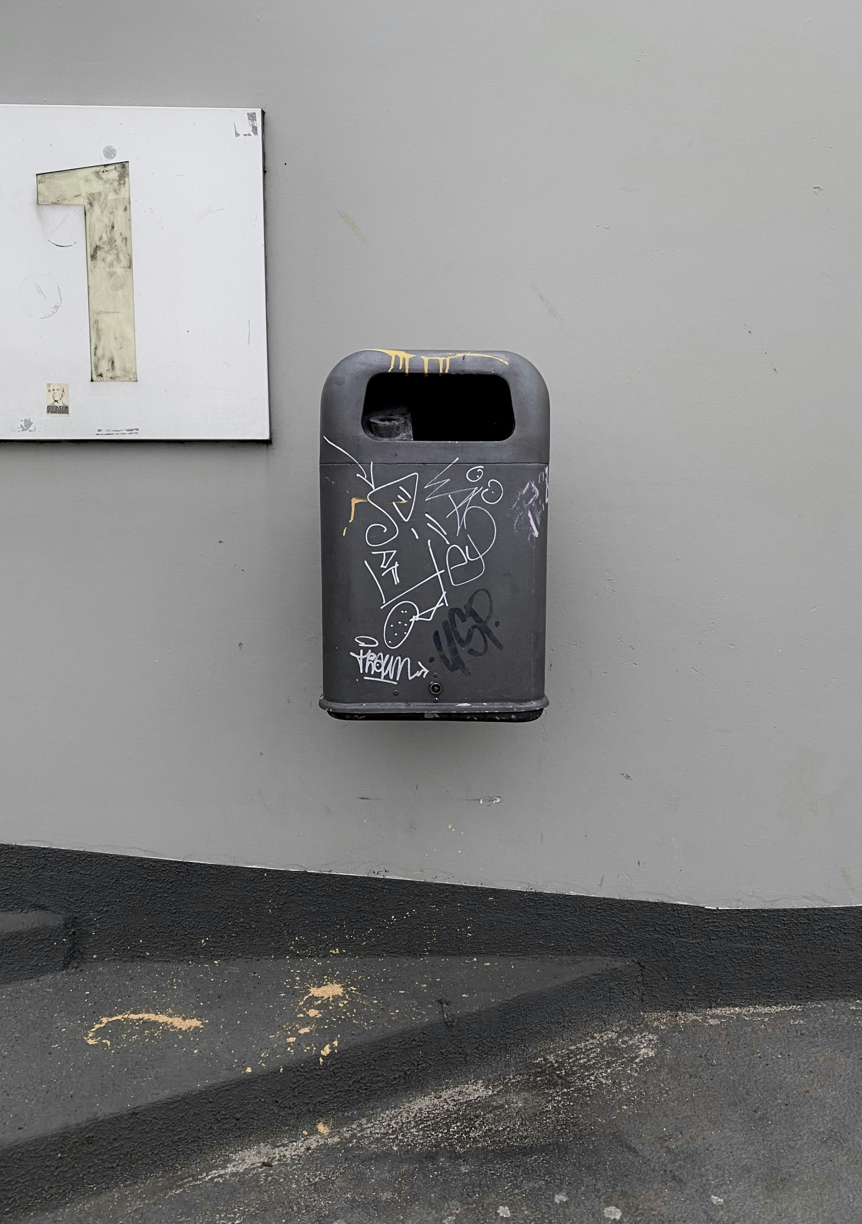 A black mailbox with graffiti on the side of a building photo – Free ...