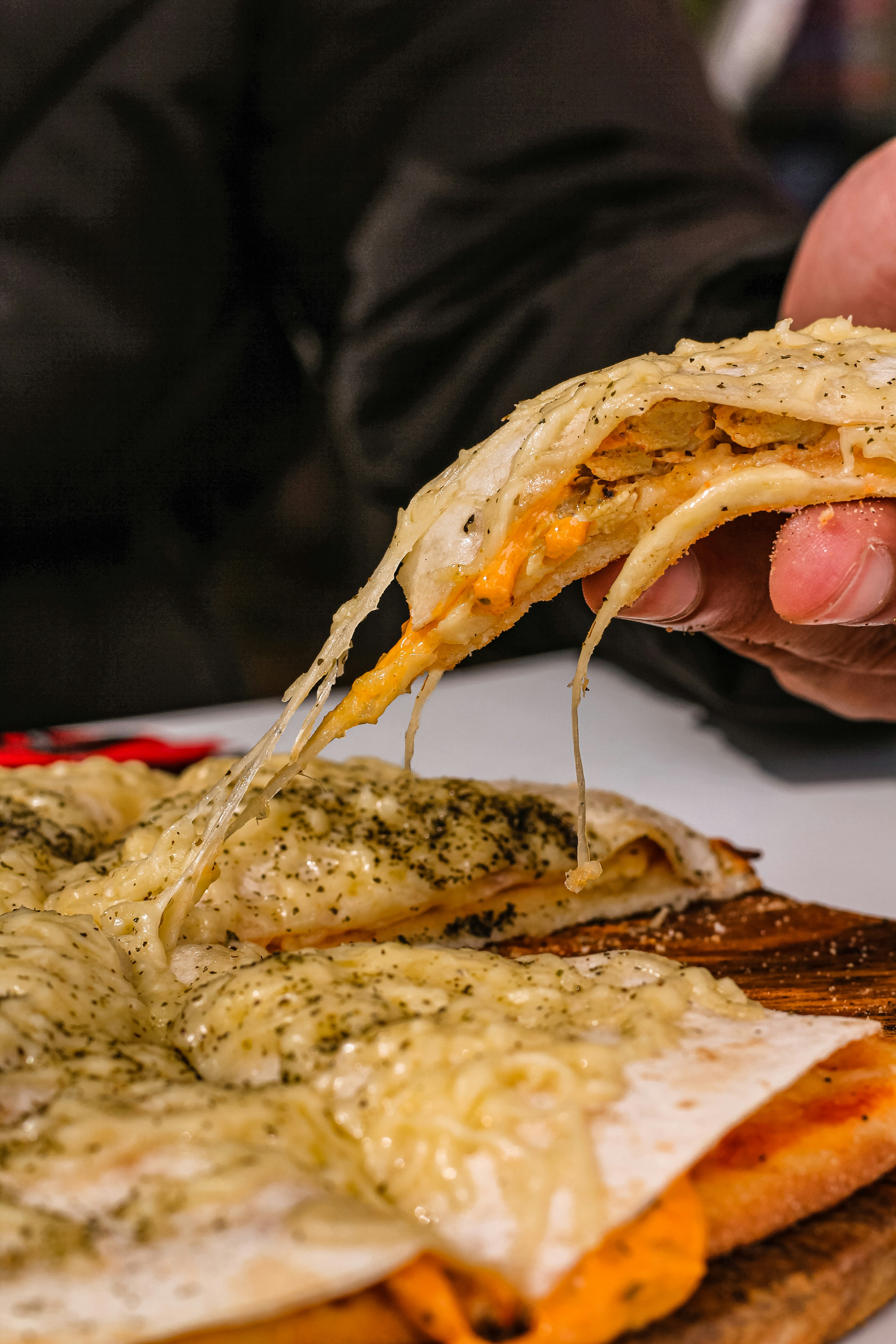 Cheese String Serenade: Melted Mozzarella Stretch Over a Golden Crust