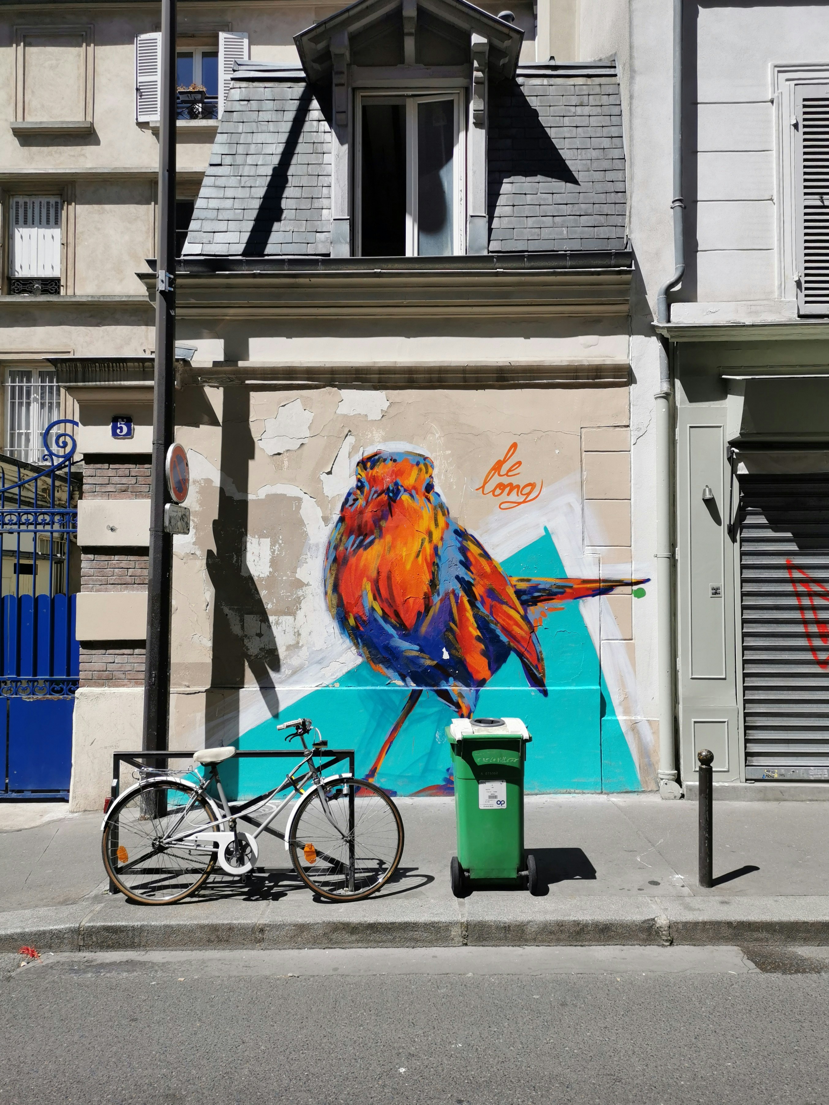 Electric Kingfisher on a Parisian Wall: Neon Orange Meets Turquoise