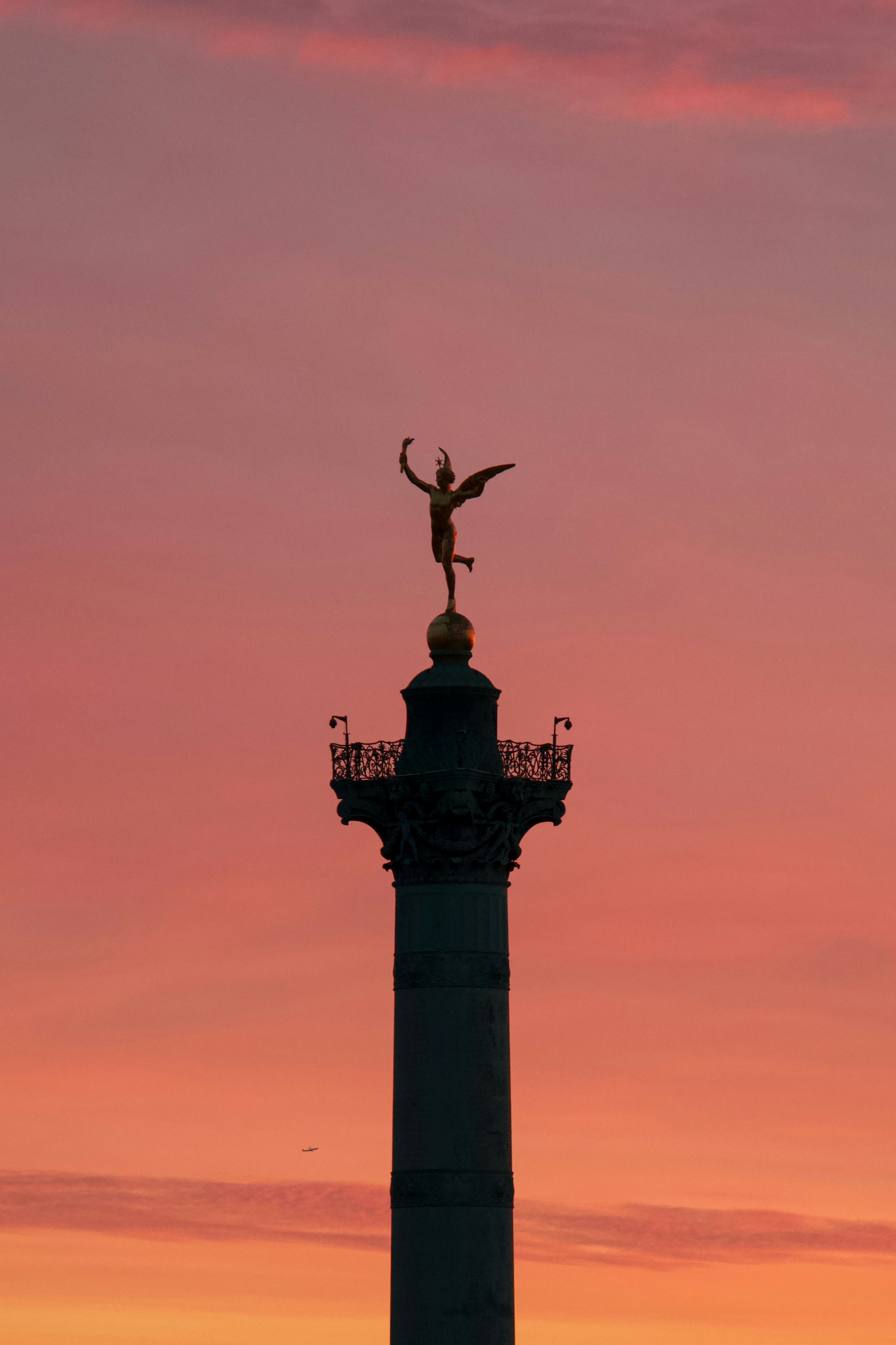 A statue on top of a tower with a bird on top of it photo – Free Sky ...