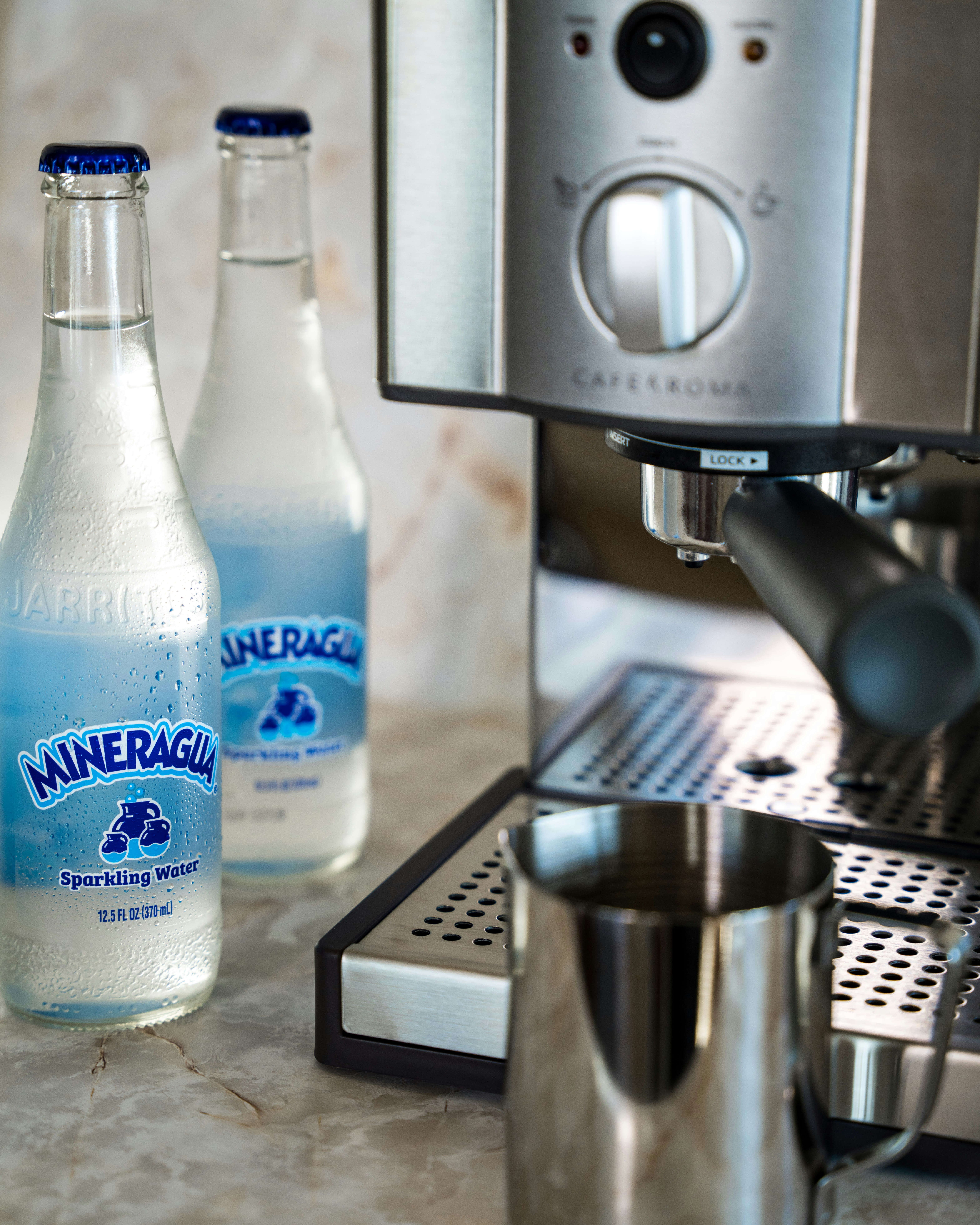 Stainless Studio: Portafilter Framed by Mineral Water Bottles