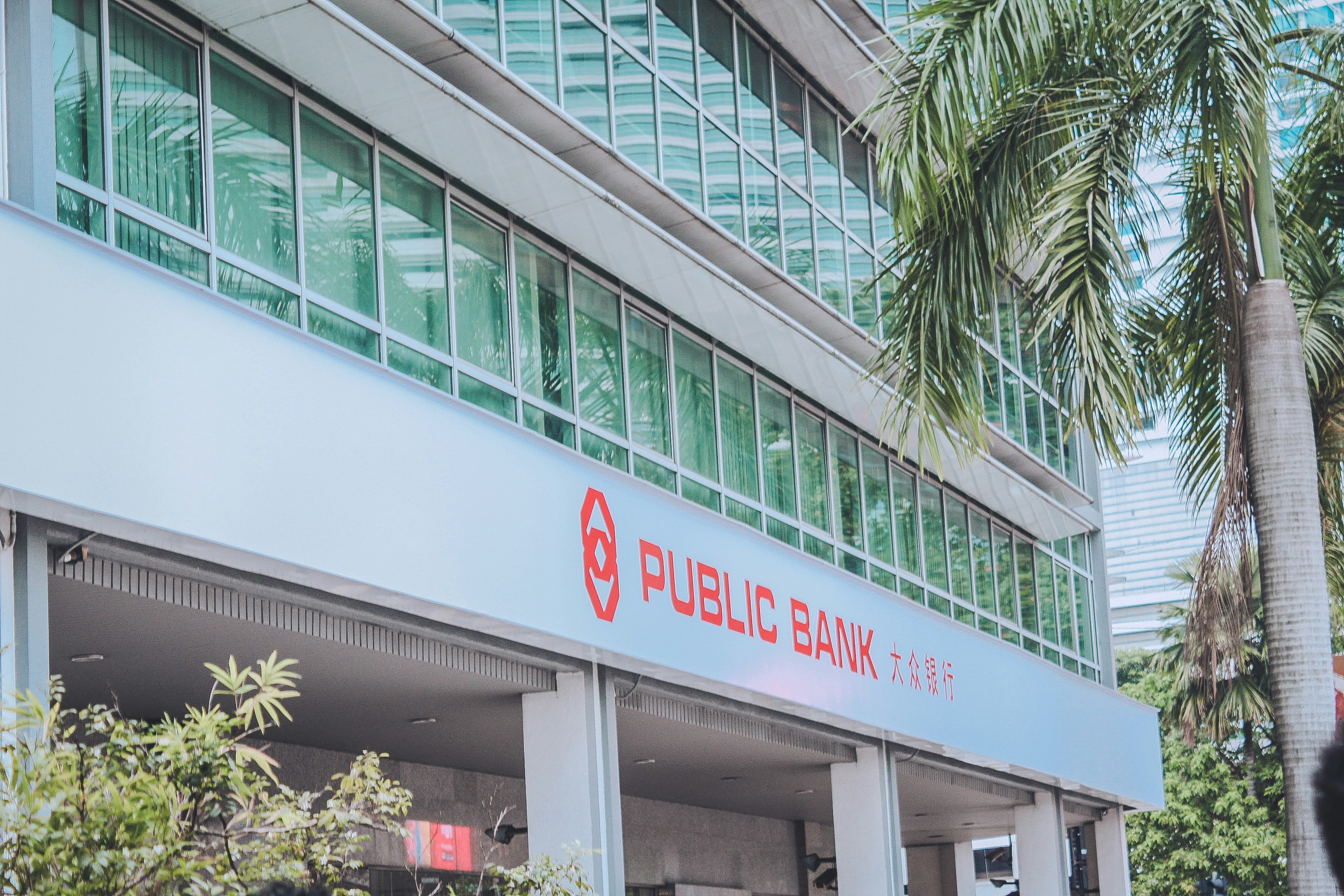 A public bank building with a palm tree in front of it photo – Free ...