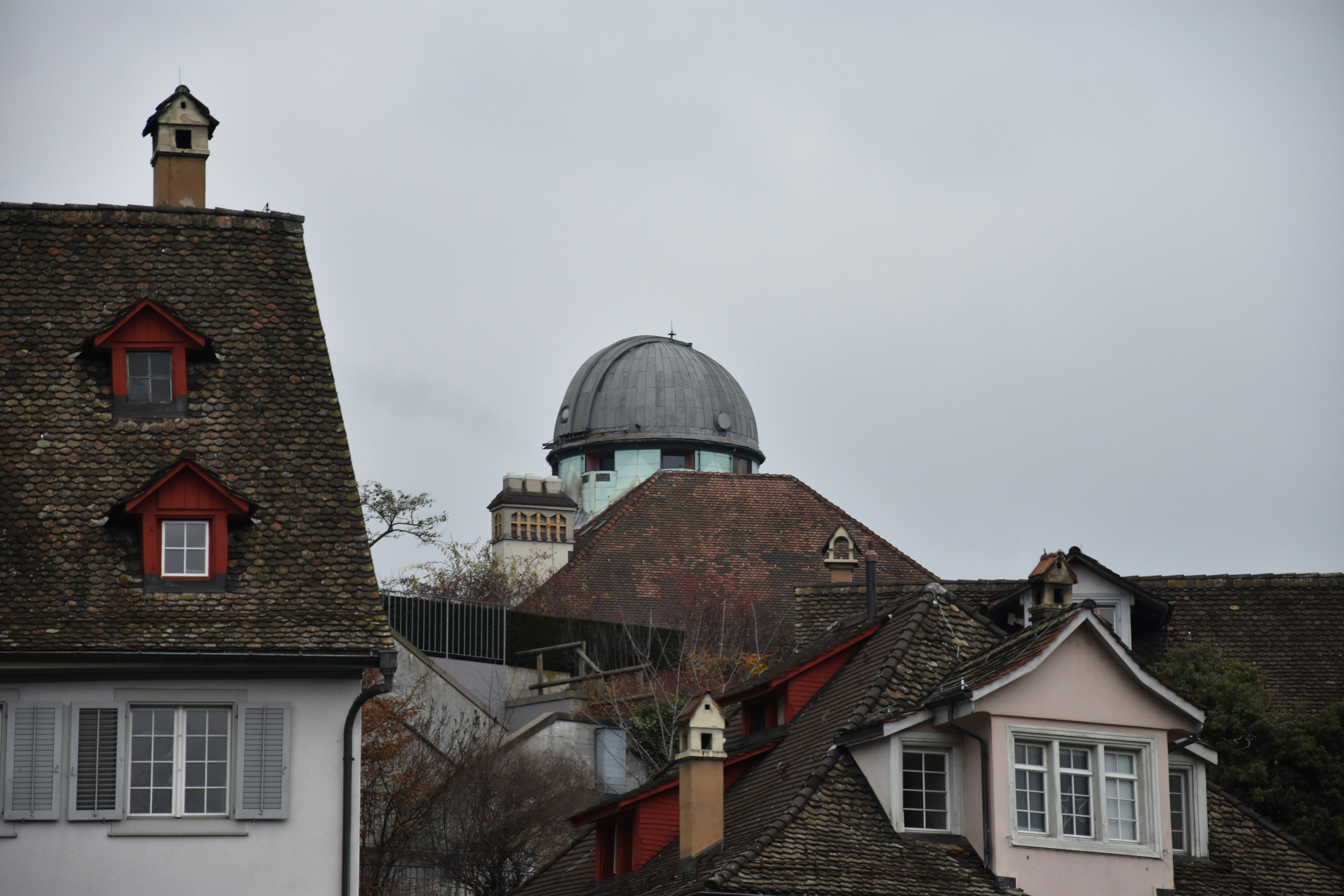 Turquoise-Domed Landmark Peeks Over a Village of Sloped Roofs