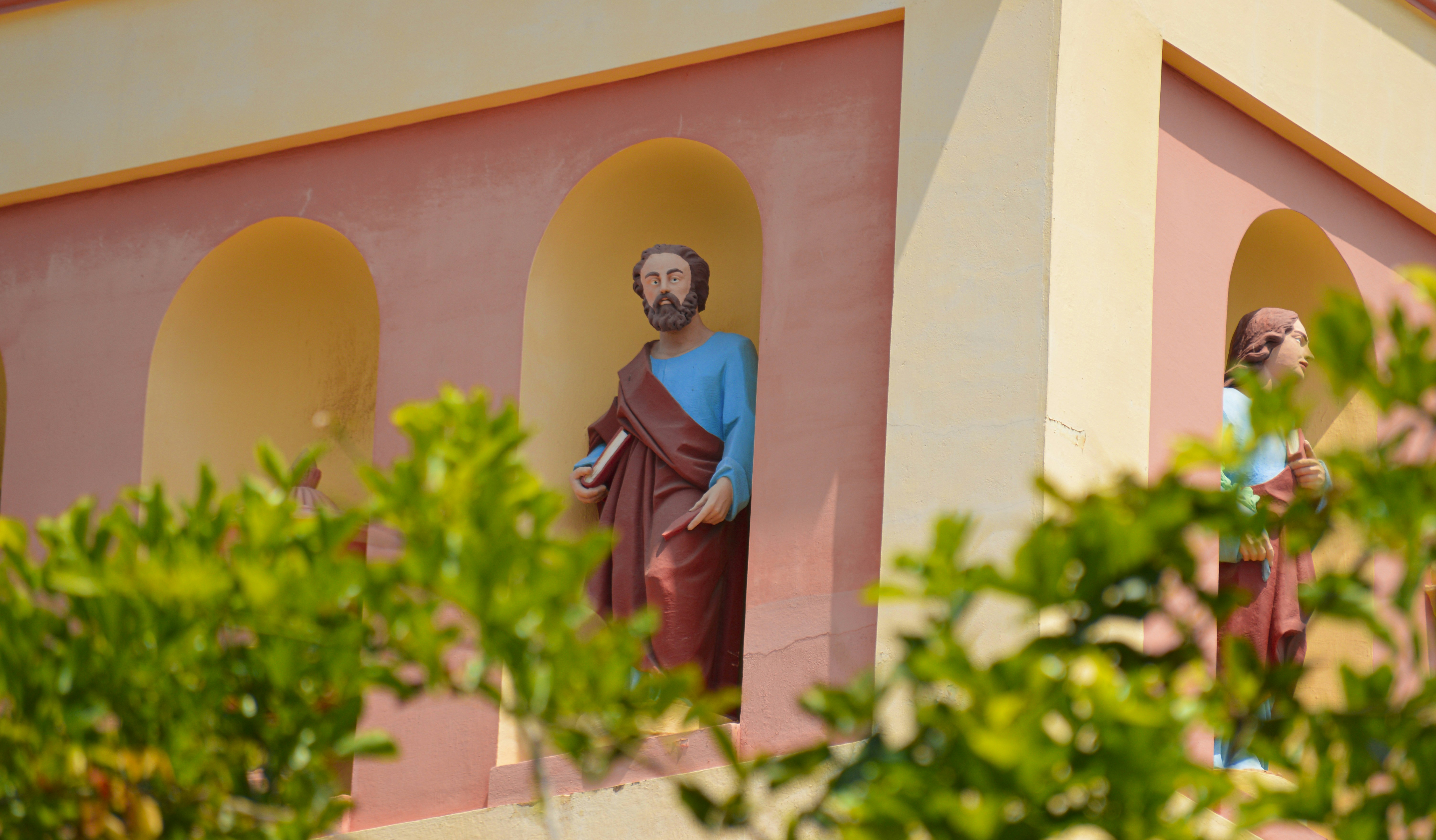 Pastel Archways: Saints in the Sunlit Niche