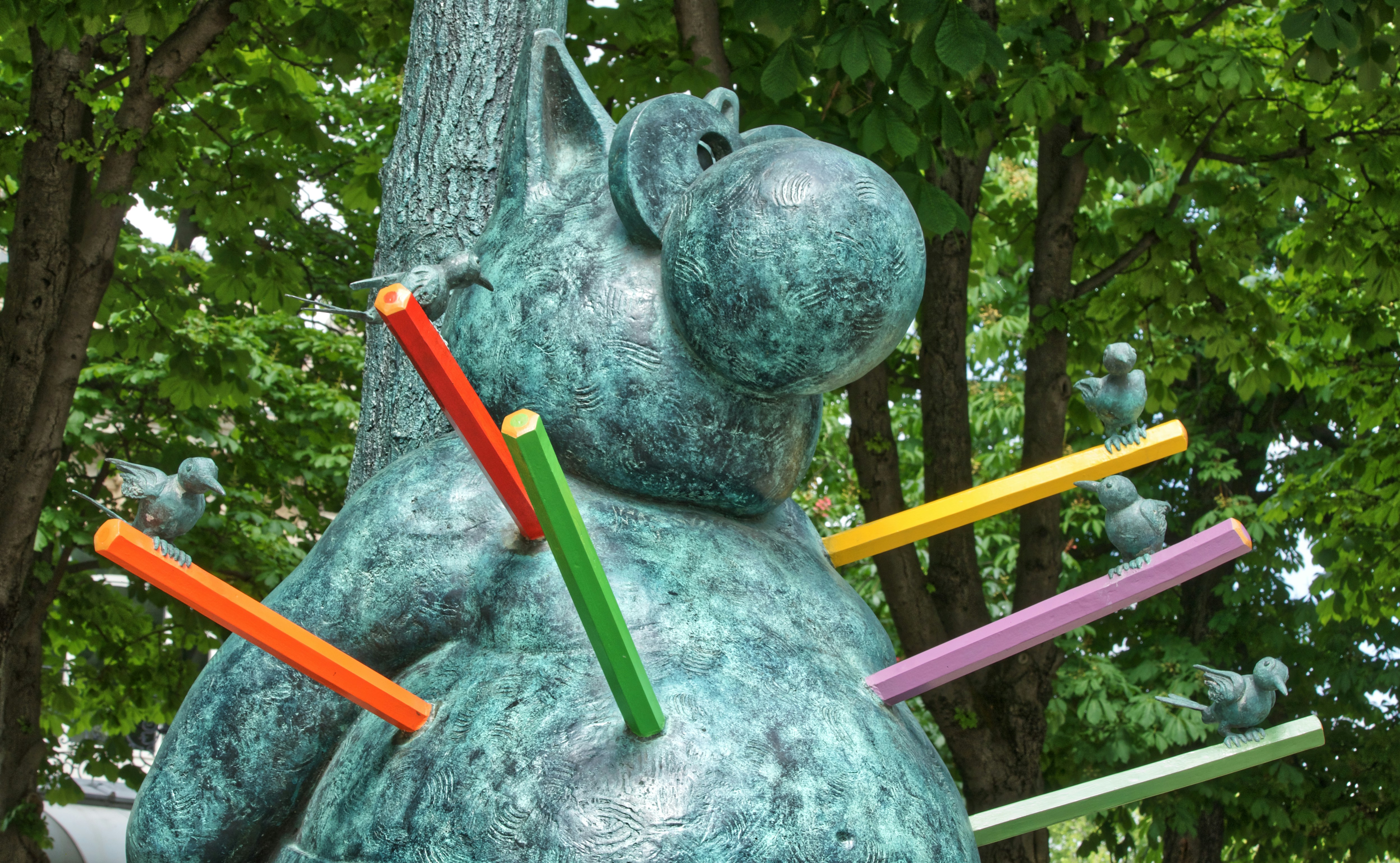 Colorful Braces on a Dragon Statue: Playful Public Art in Green Shade