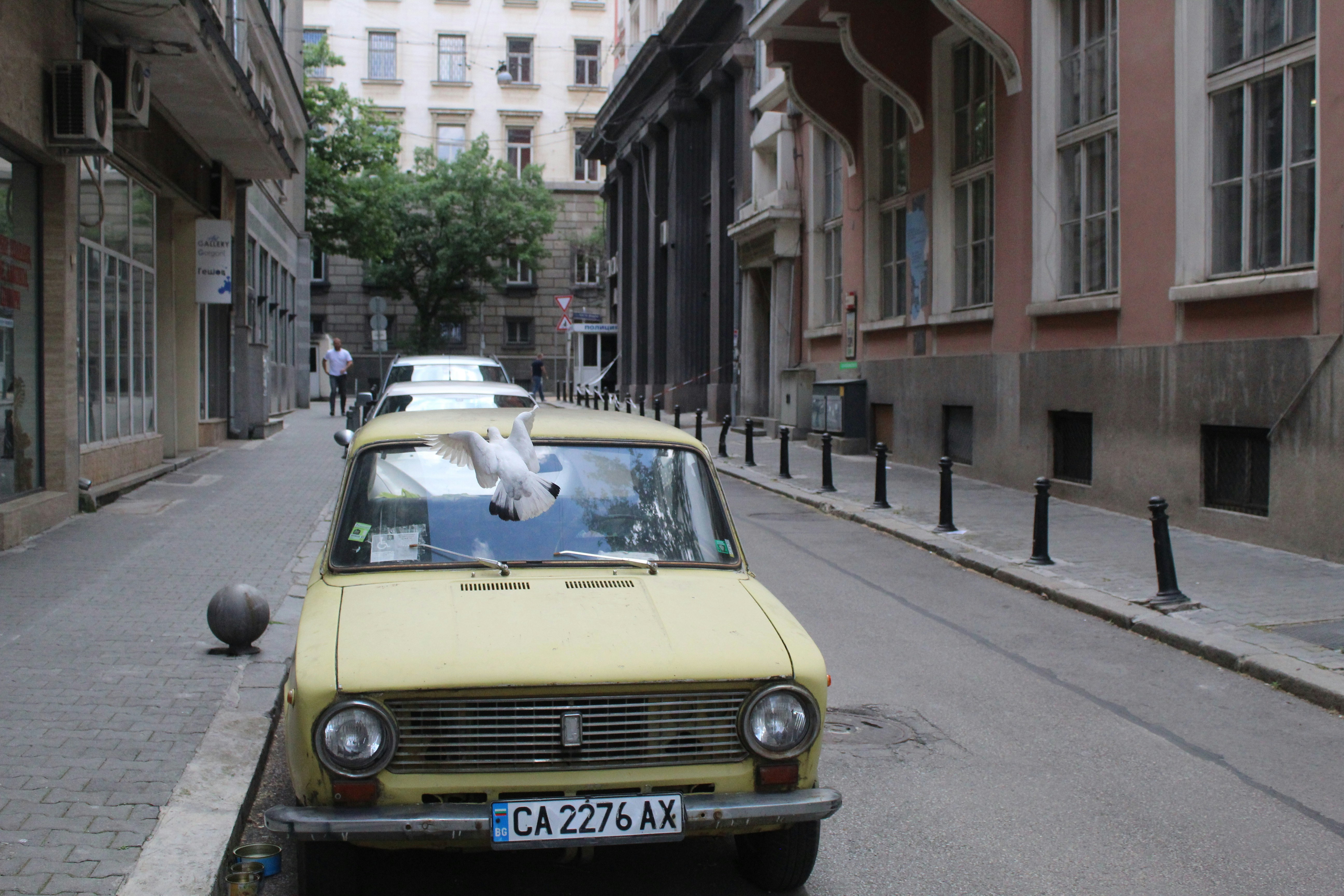 Yellow Vintage Car on a Cobblestone Street