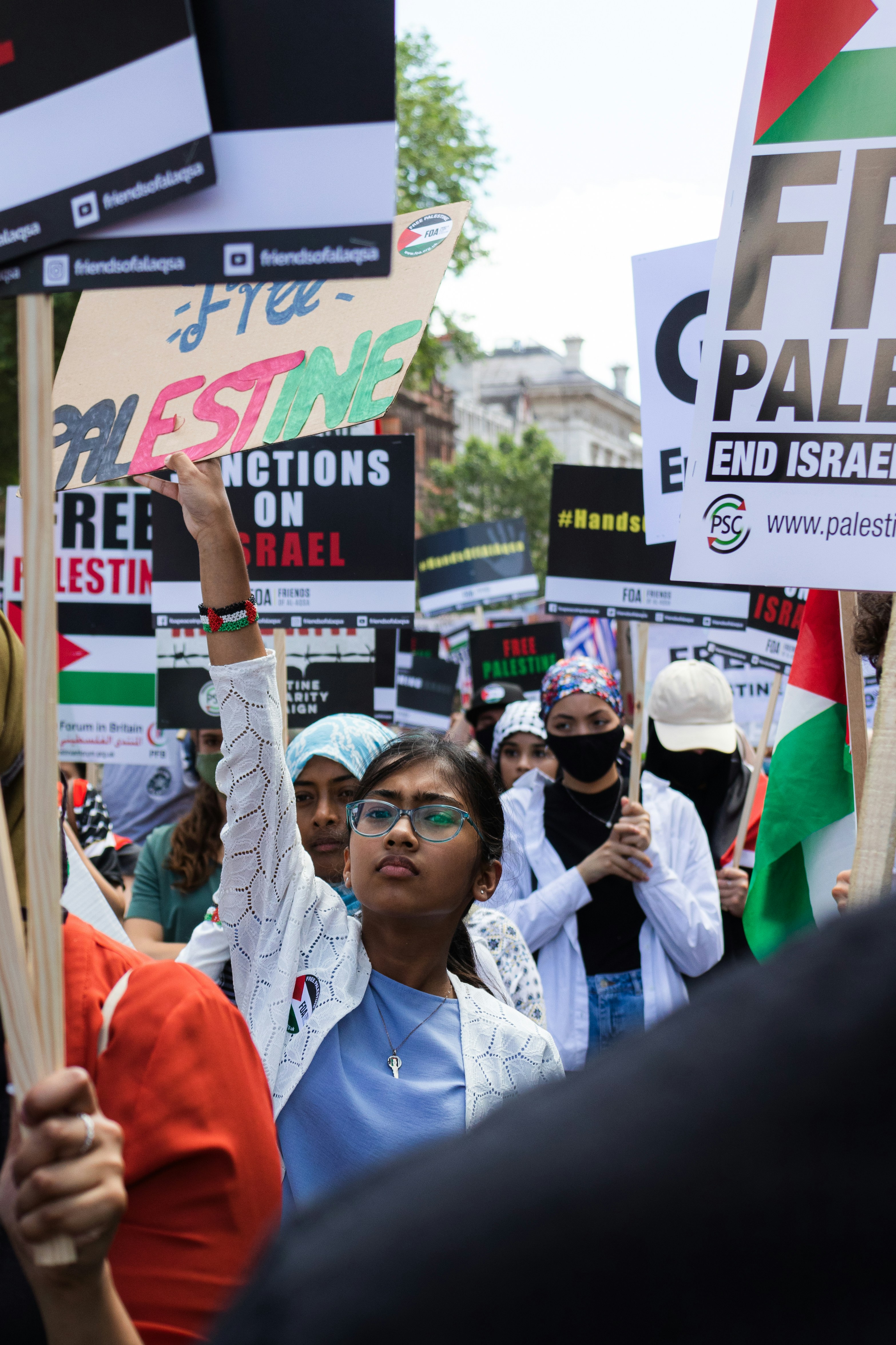 A group of people holding up signs in a protest photo – Free Protest ...