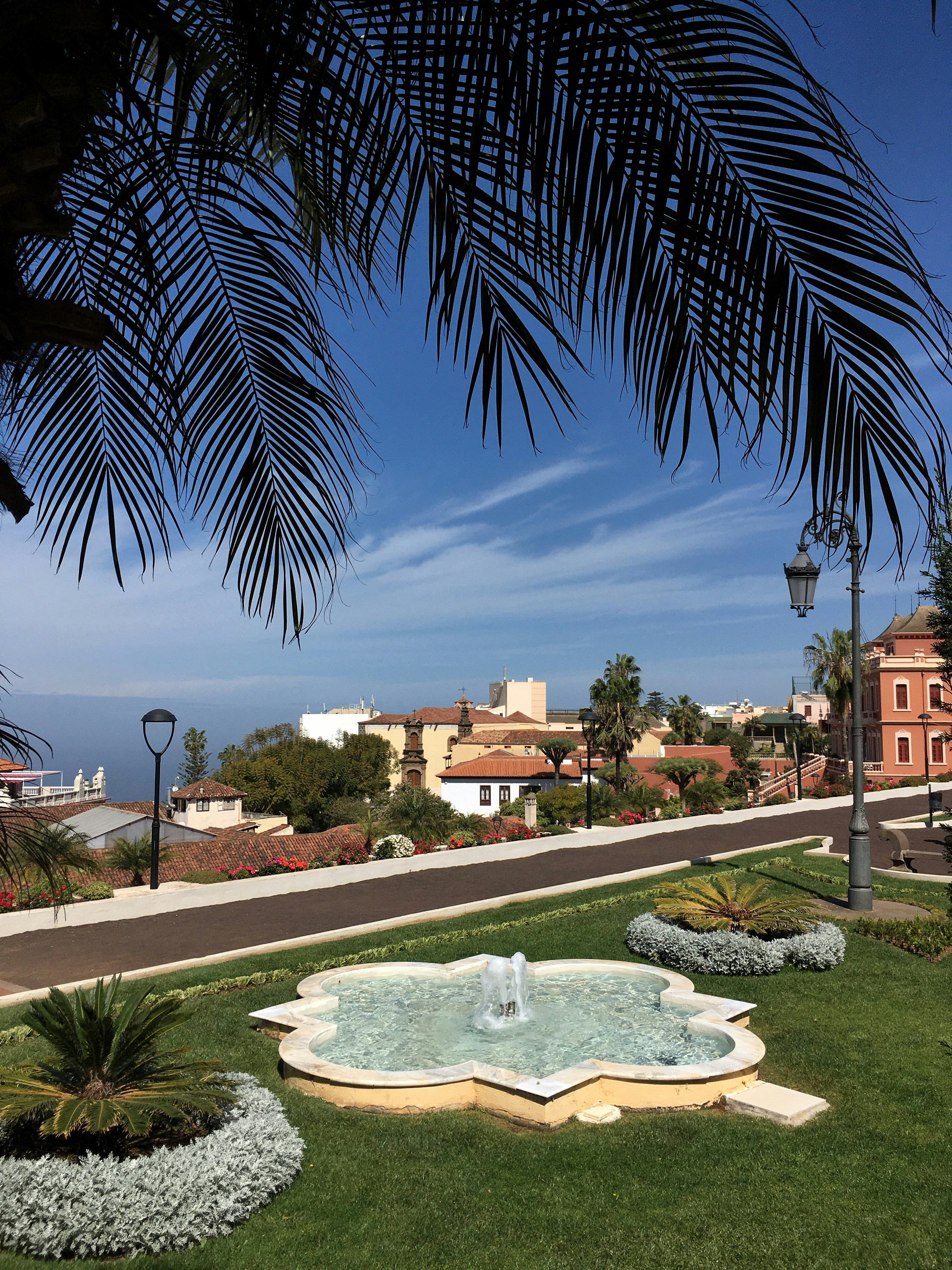 Sunlit Plaza with Fountain and Oceanview