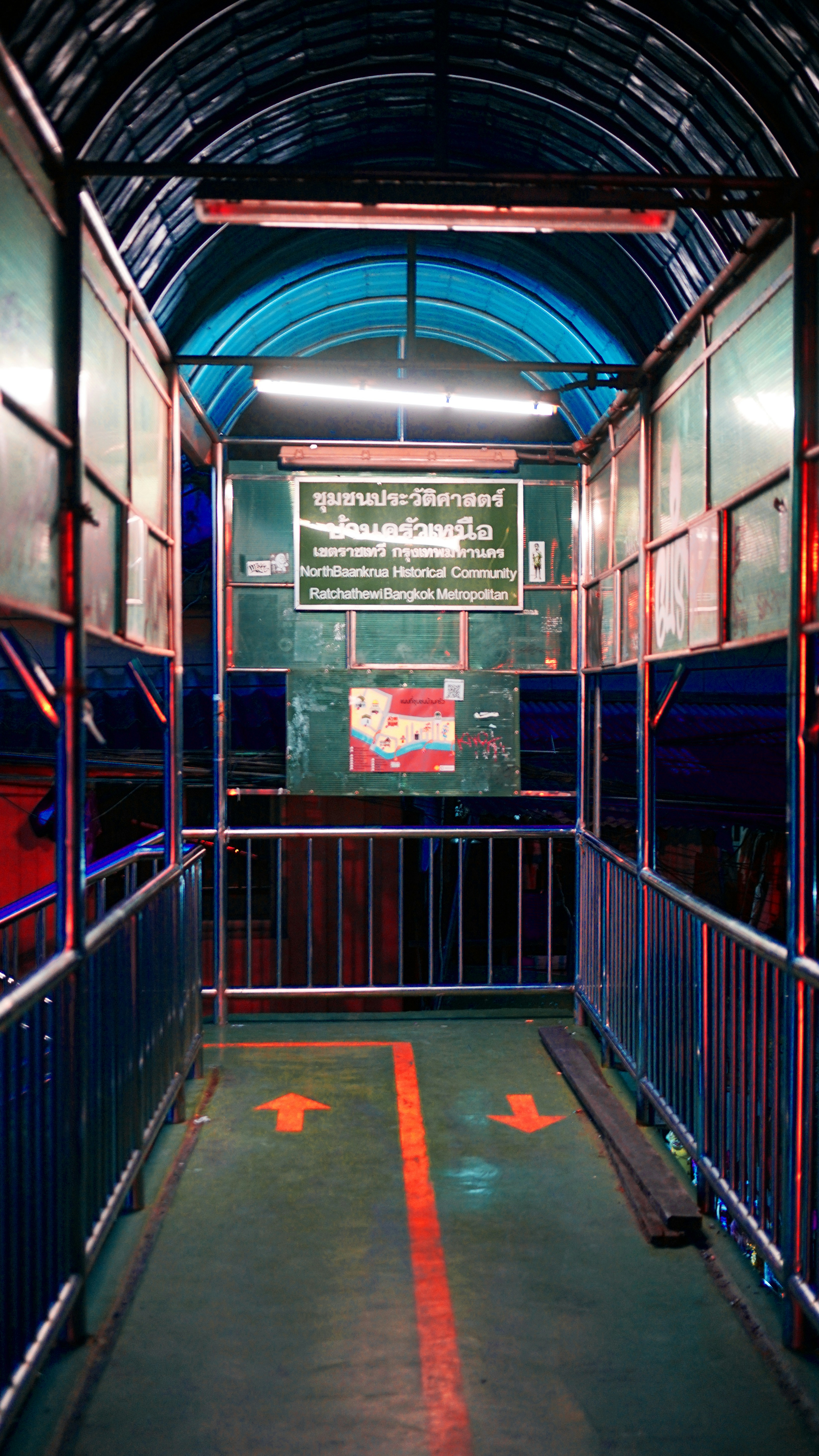 Red metal railings near green and brown wooden signage photo – Free ...