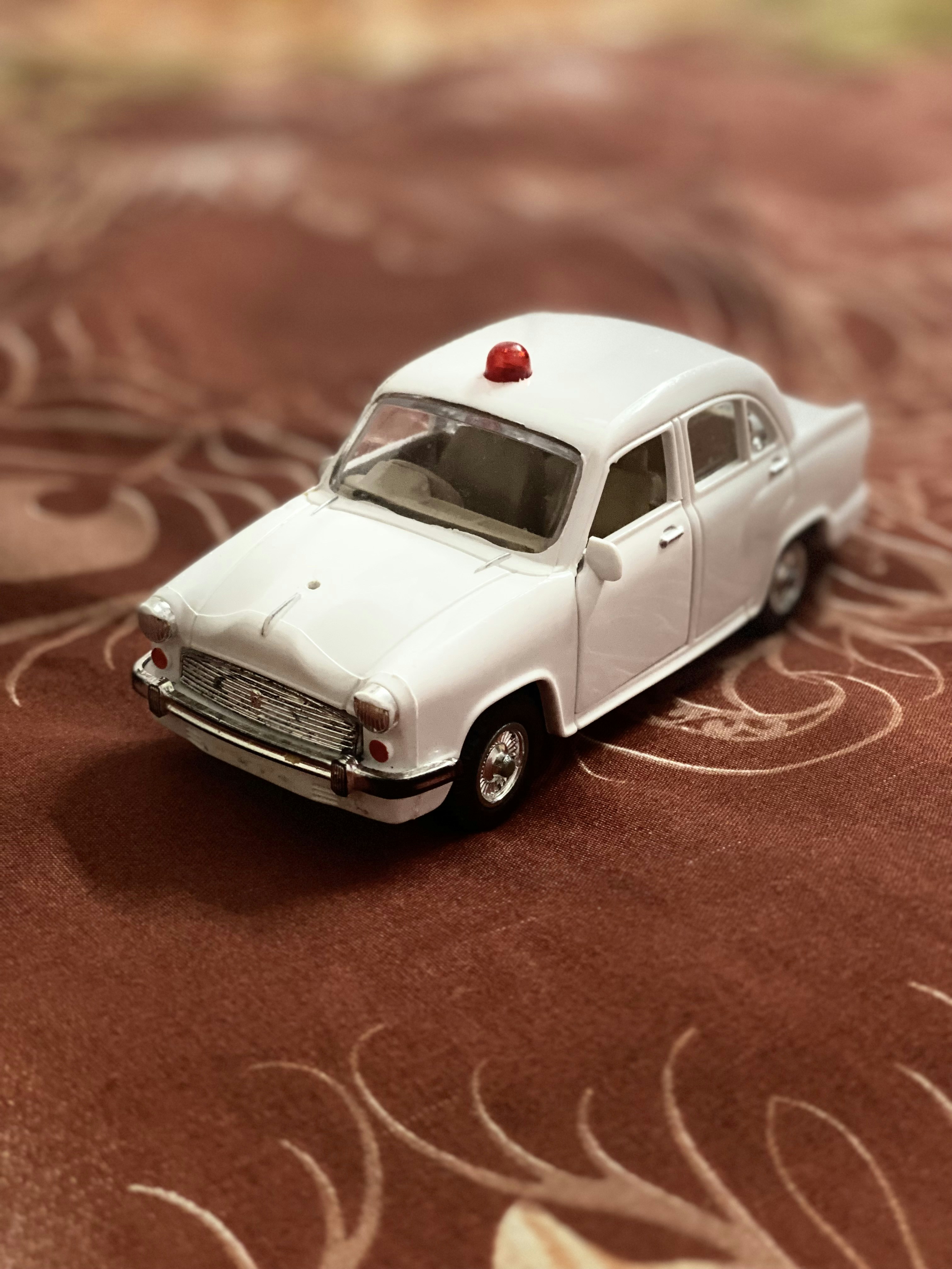 Tiny Vintage Patrol: A Mini Car Under Soft Studio Light