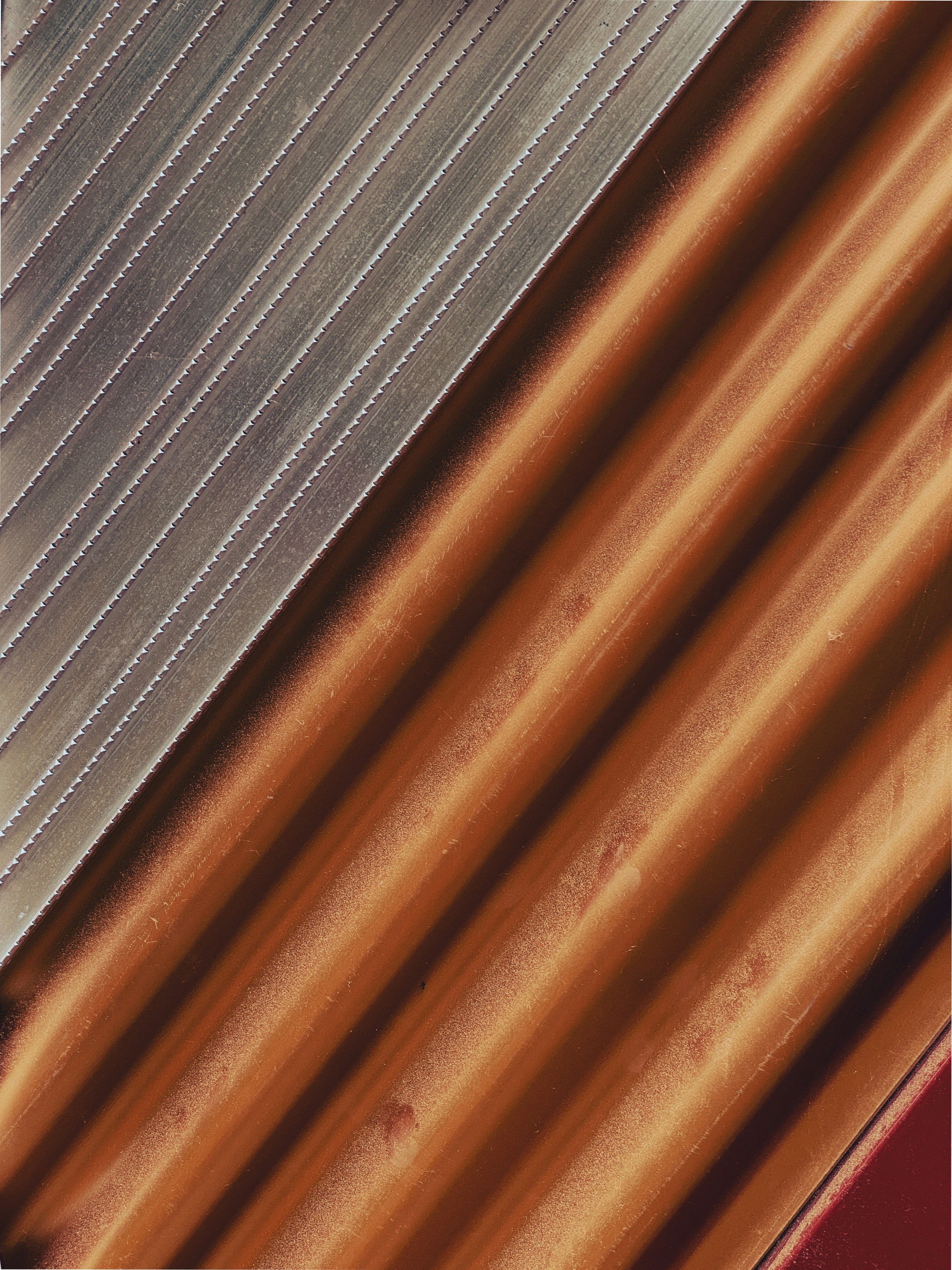 Industrial Rhythms: Close-Up of Corrugated Metal in Warm Copper Tones