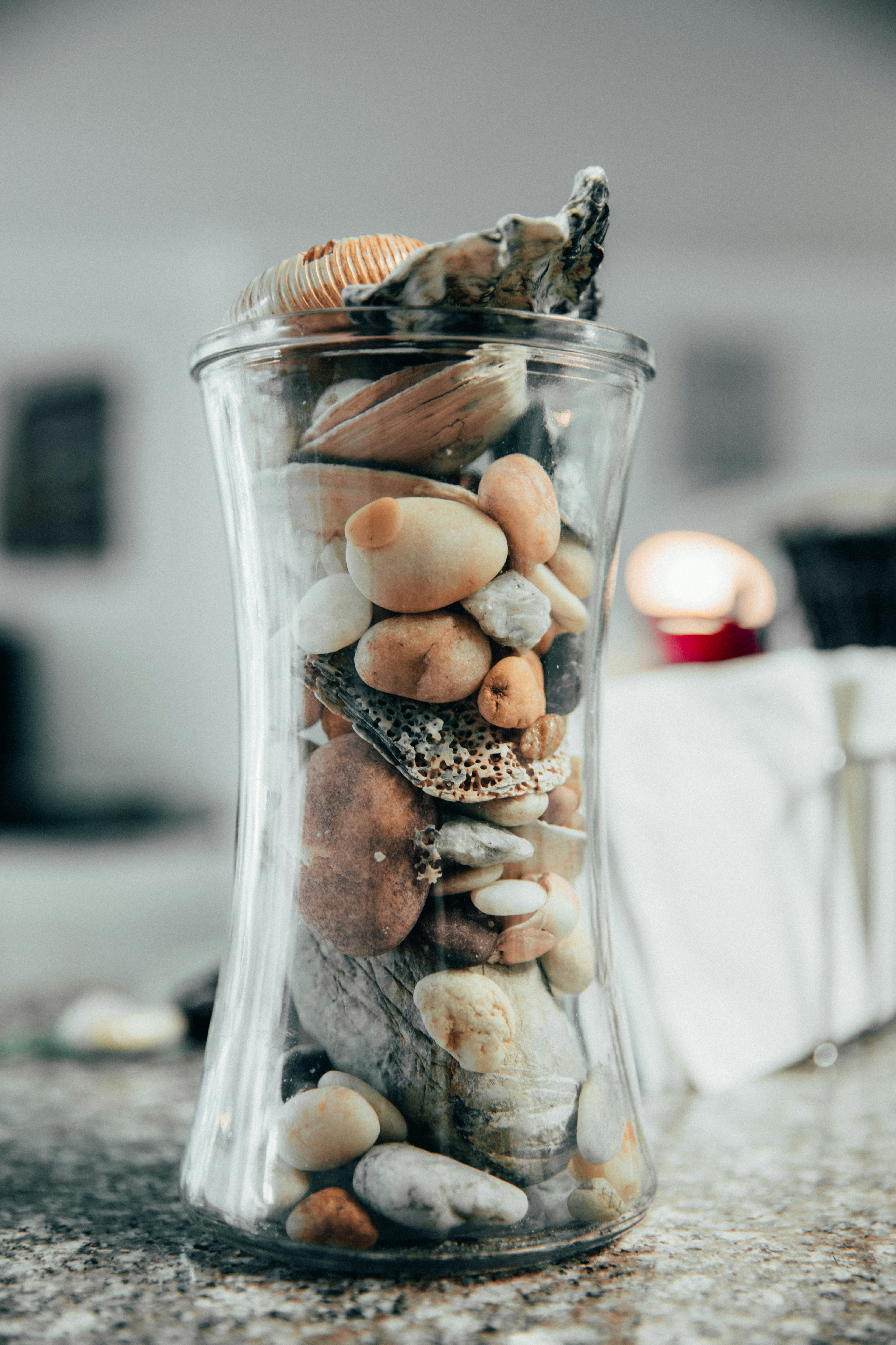 Glass Vase of Smooth Stones and Seashells Anchors a Quiet Kitchen Moment